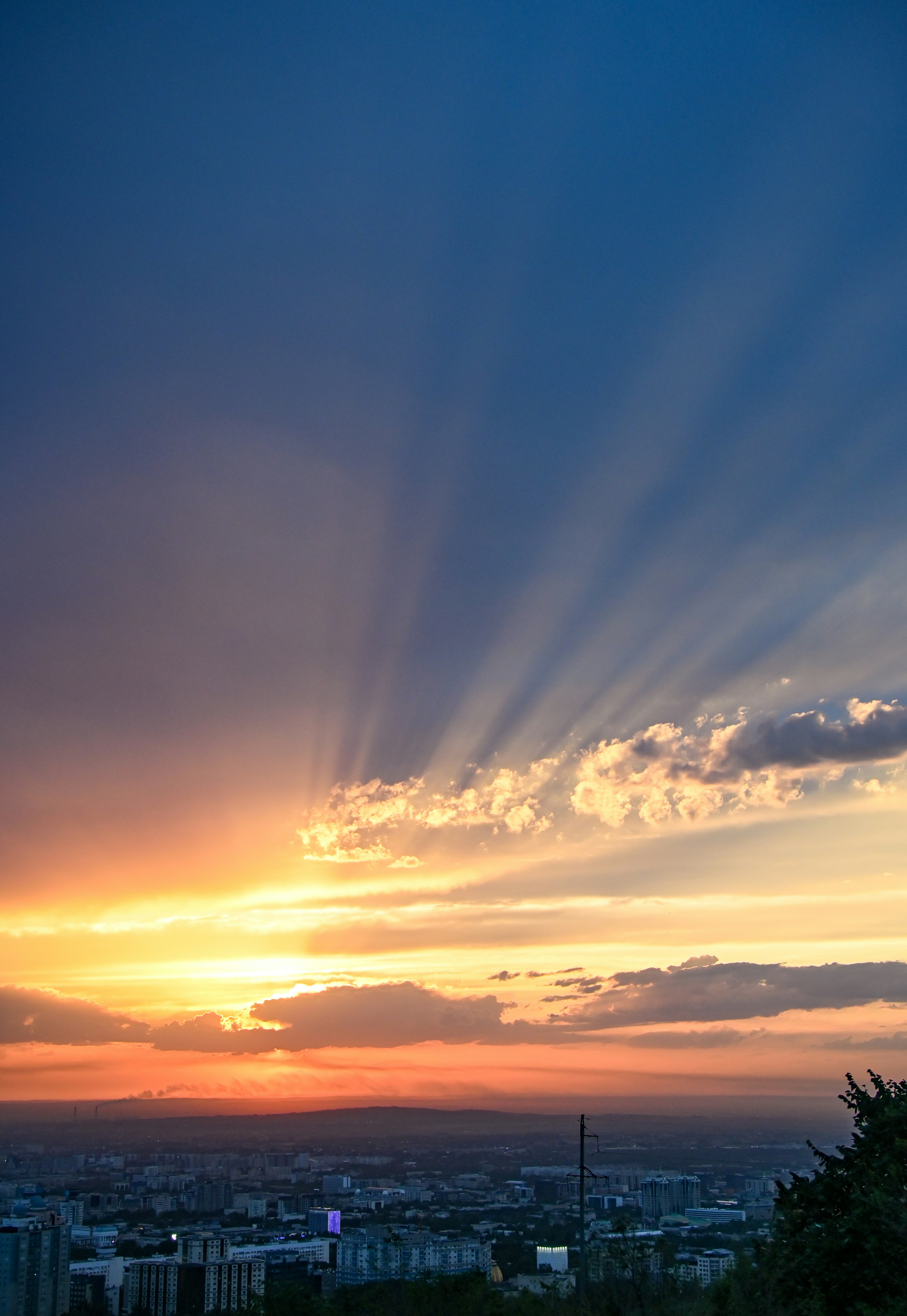 Emerging Rays Over the City at Dusk