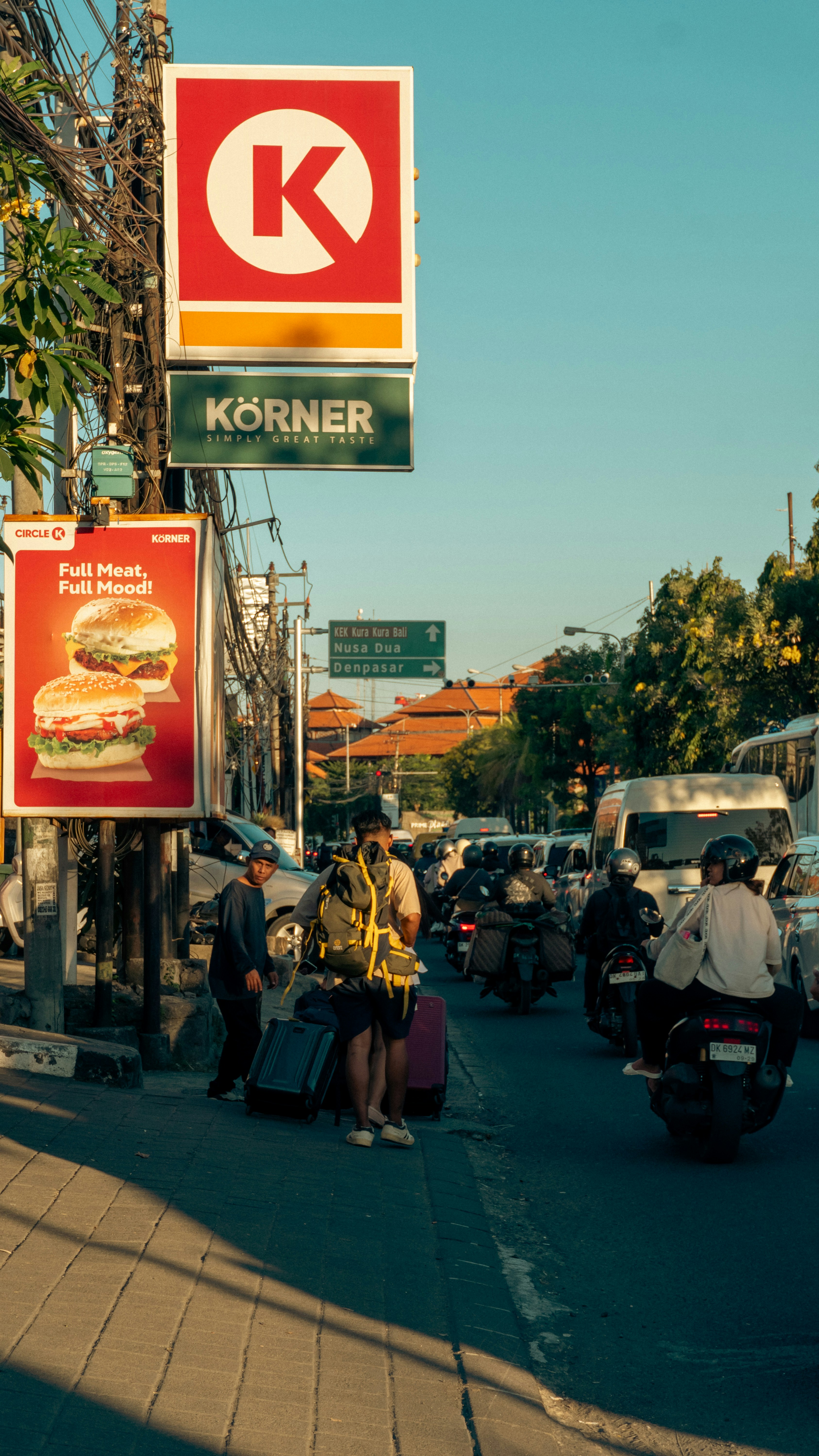 Street Snapshot at Korner: Travelers, Motorbikes and a Sunlit Corner