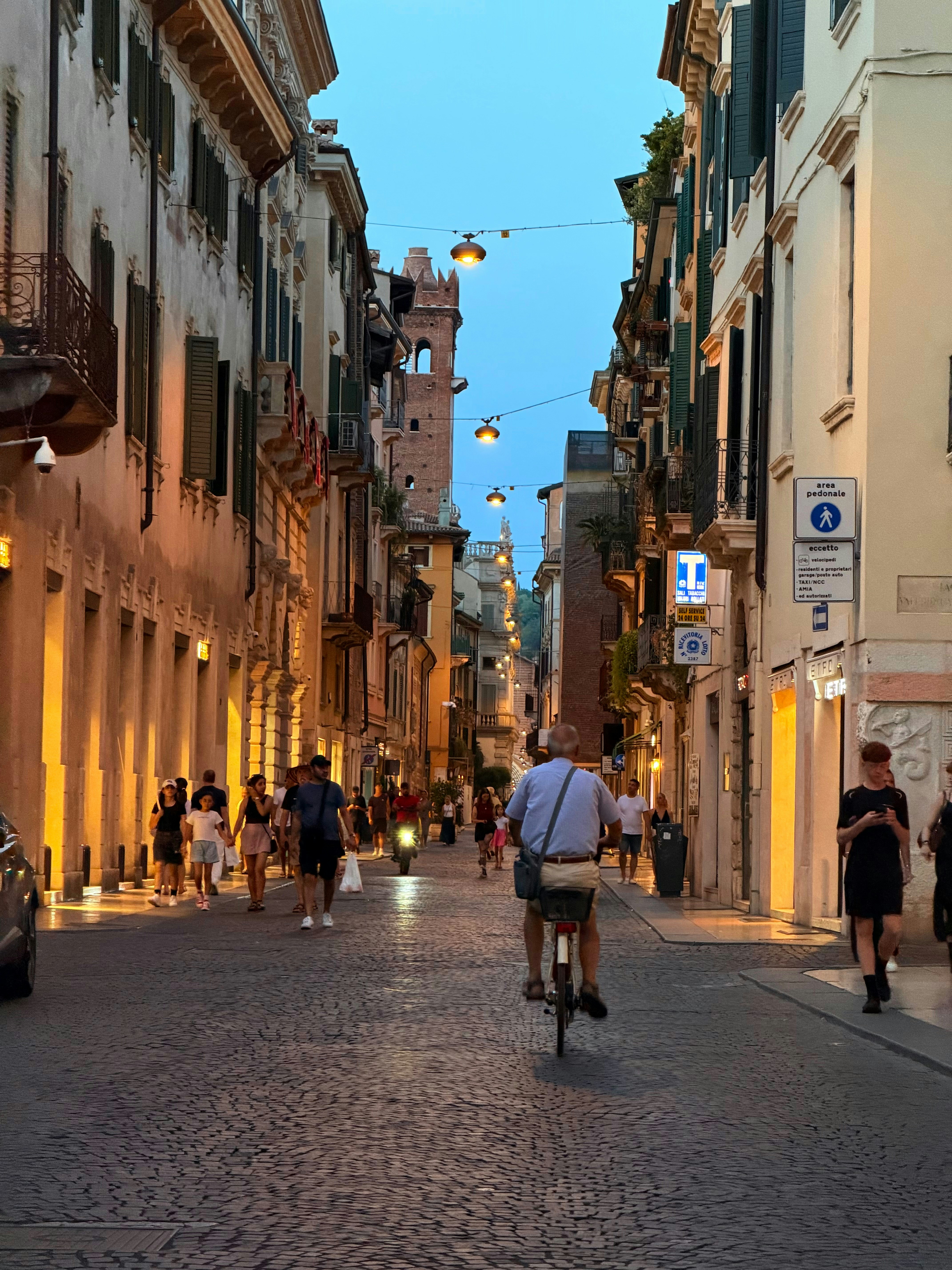 Cyclist on a Historic Street at Dusk