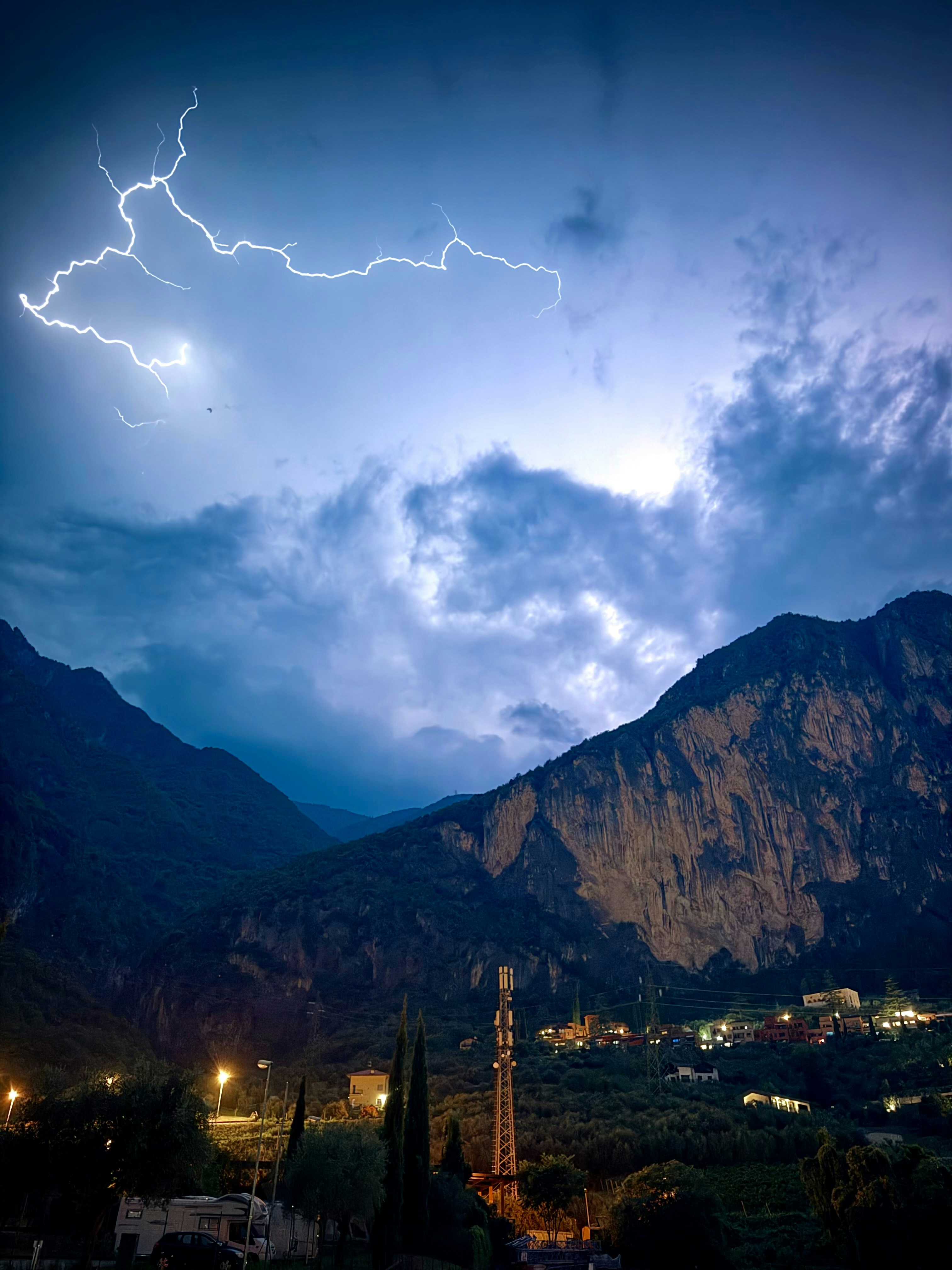 Lightning over a Mountain Village: Nighttime Storm Backdrop
