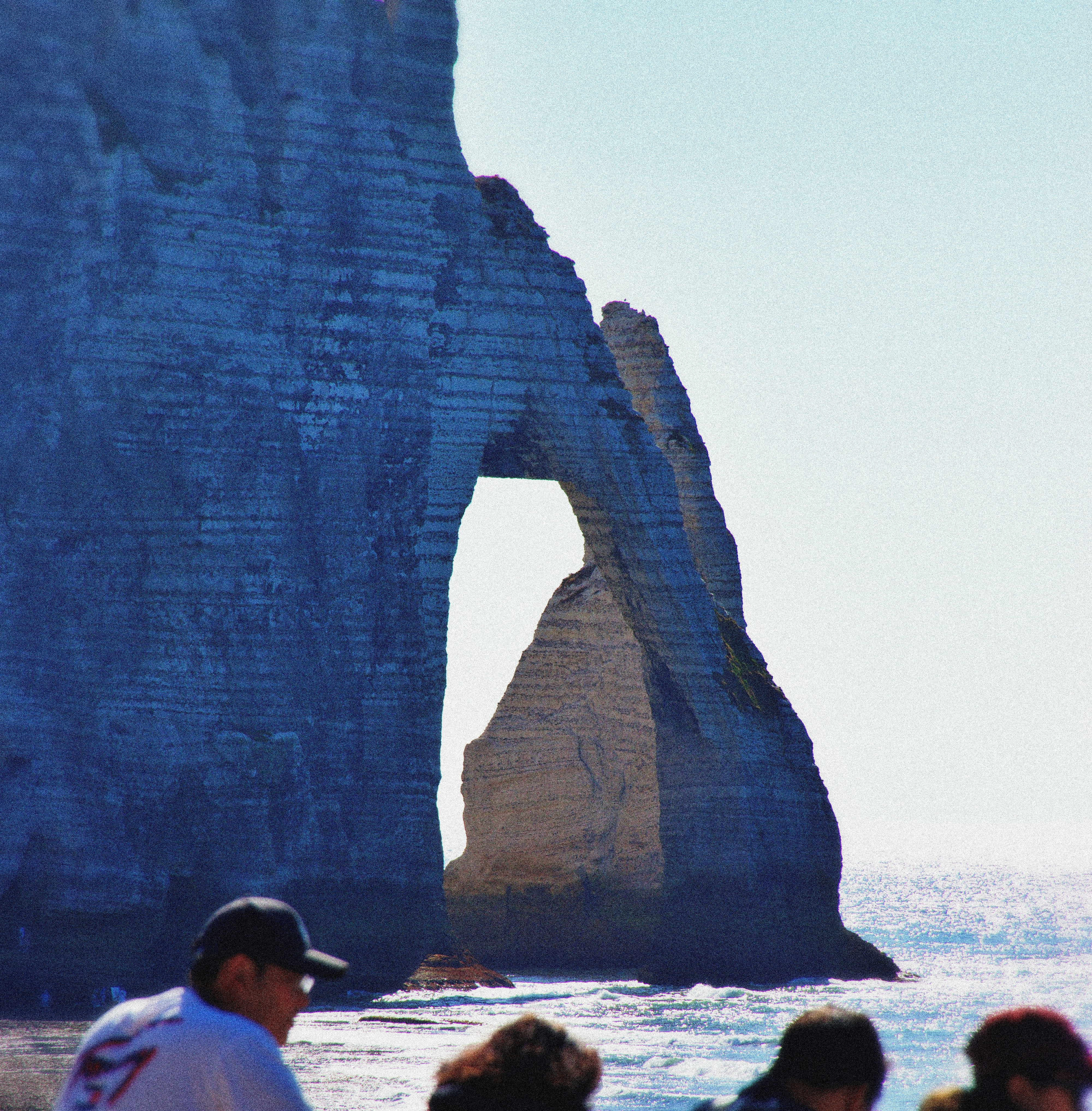 Natural Sea Arch Framed by Crowded Beachgoers