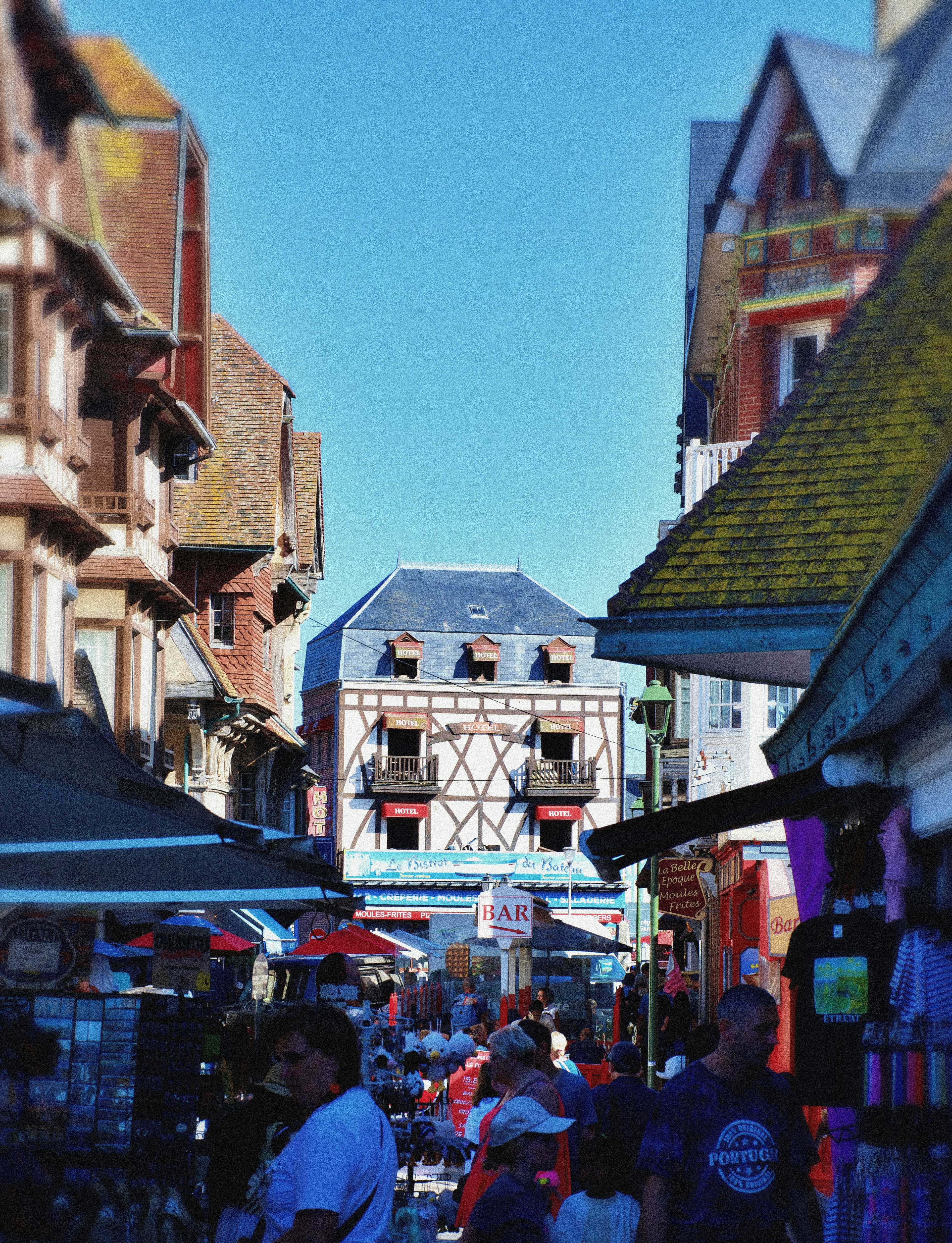 Sunlit Lane Between Timbered Houses in a Busy Market