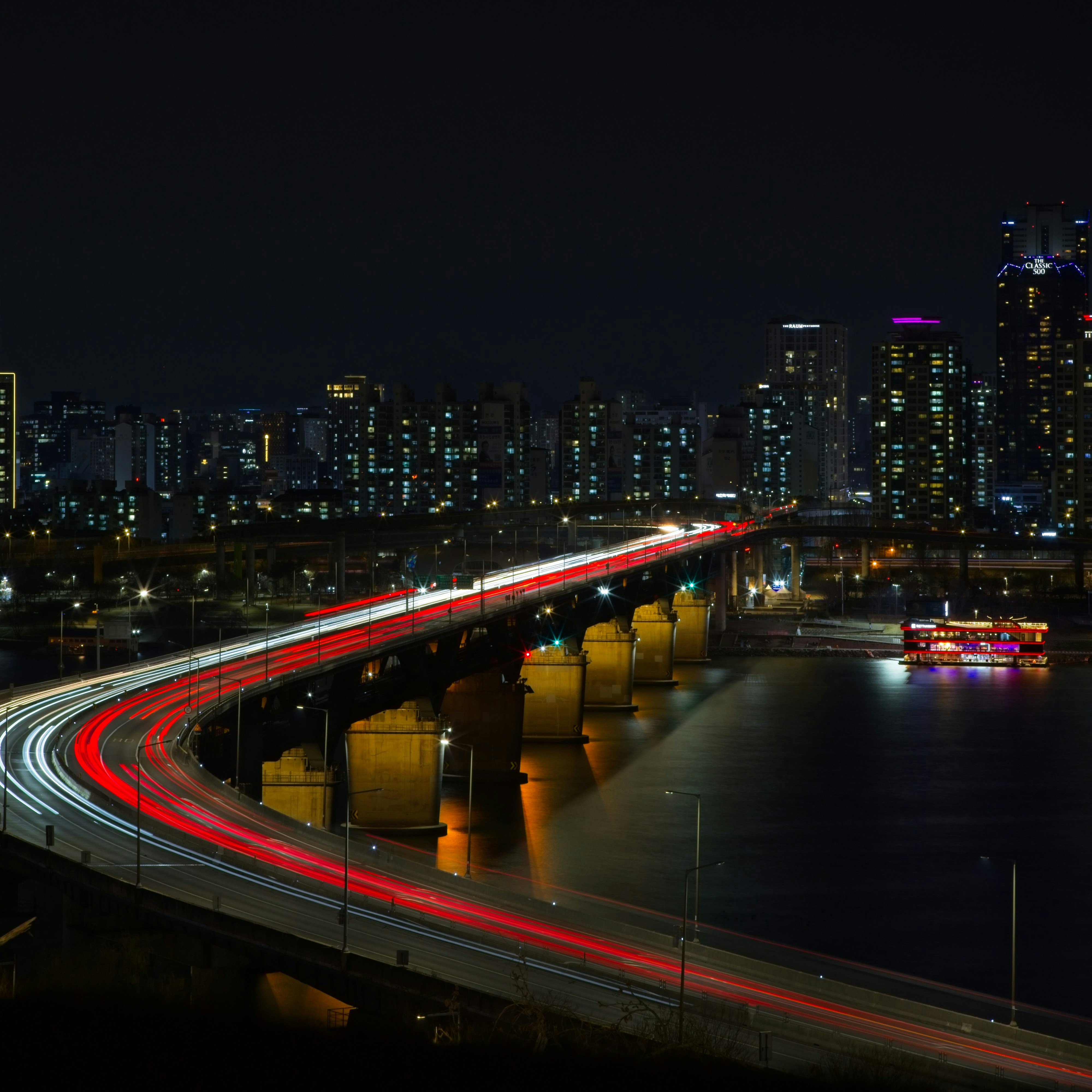 Night Pulse Over the Bridge: Neon Trails on a City Silhouette