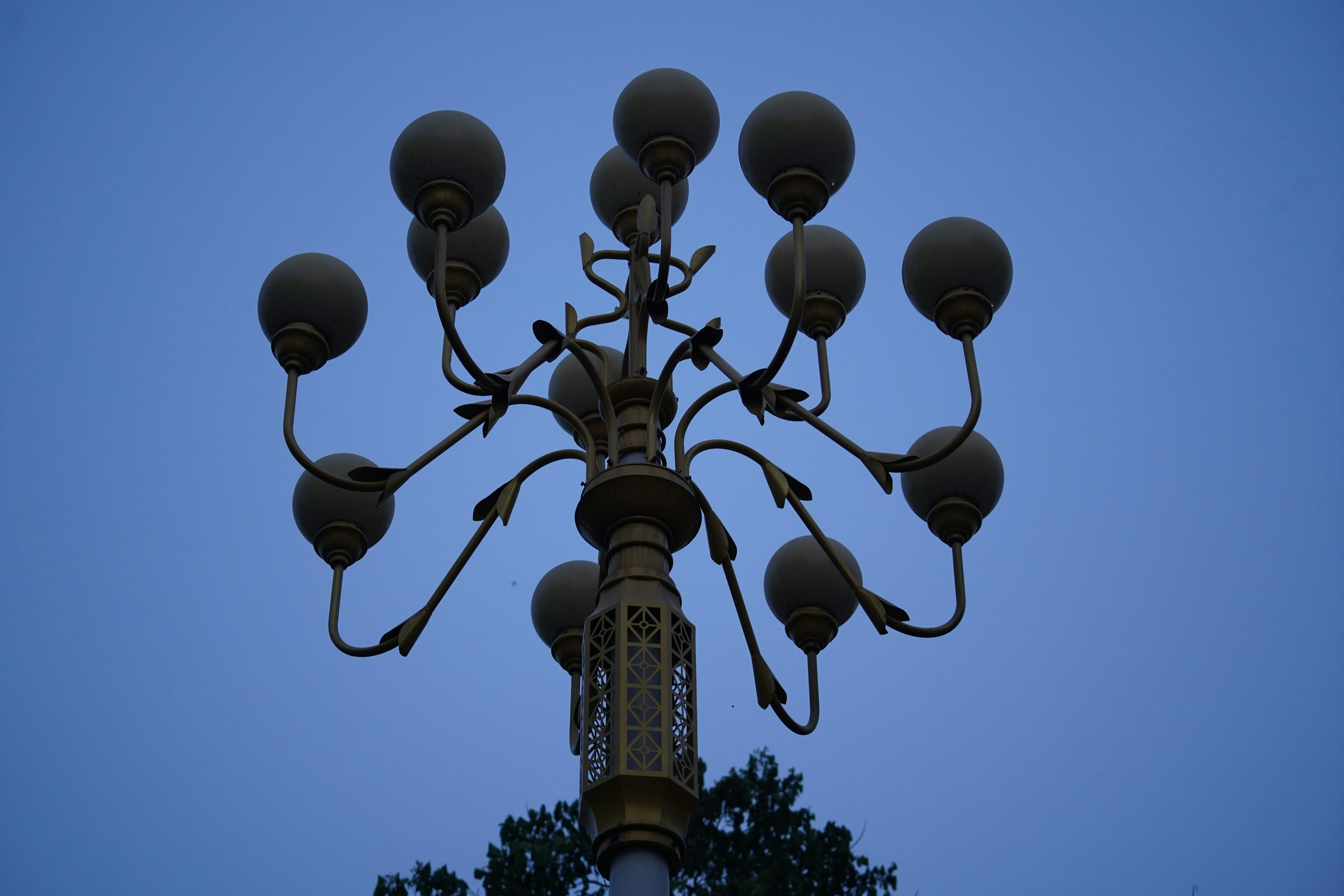 Ornate Lamppost Crowned by Orbs Against a Clear Blue Sky
