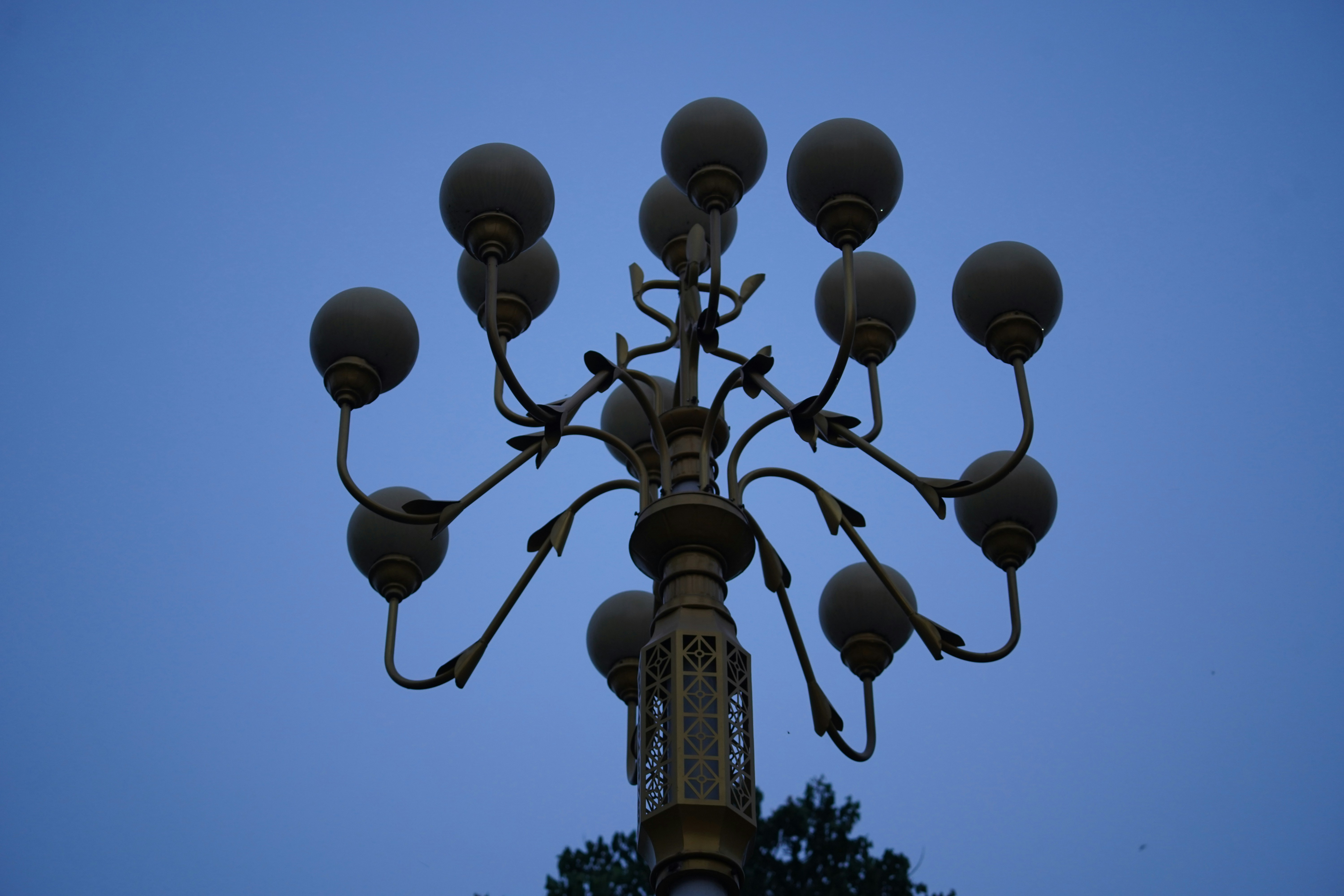 Ornate lamppost silhouette against dusk sky