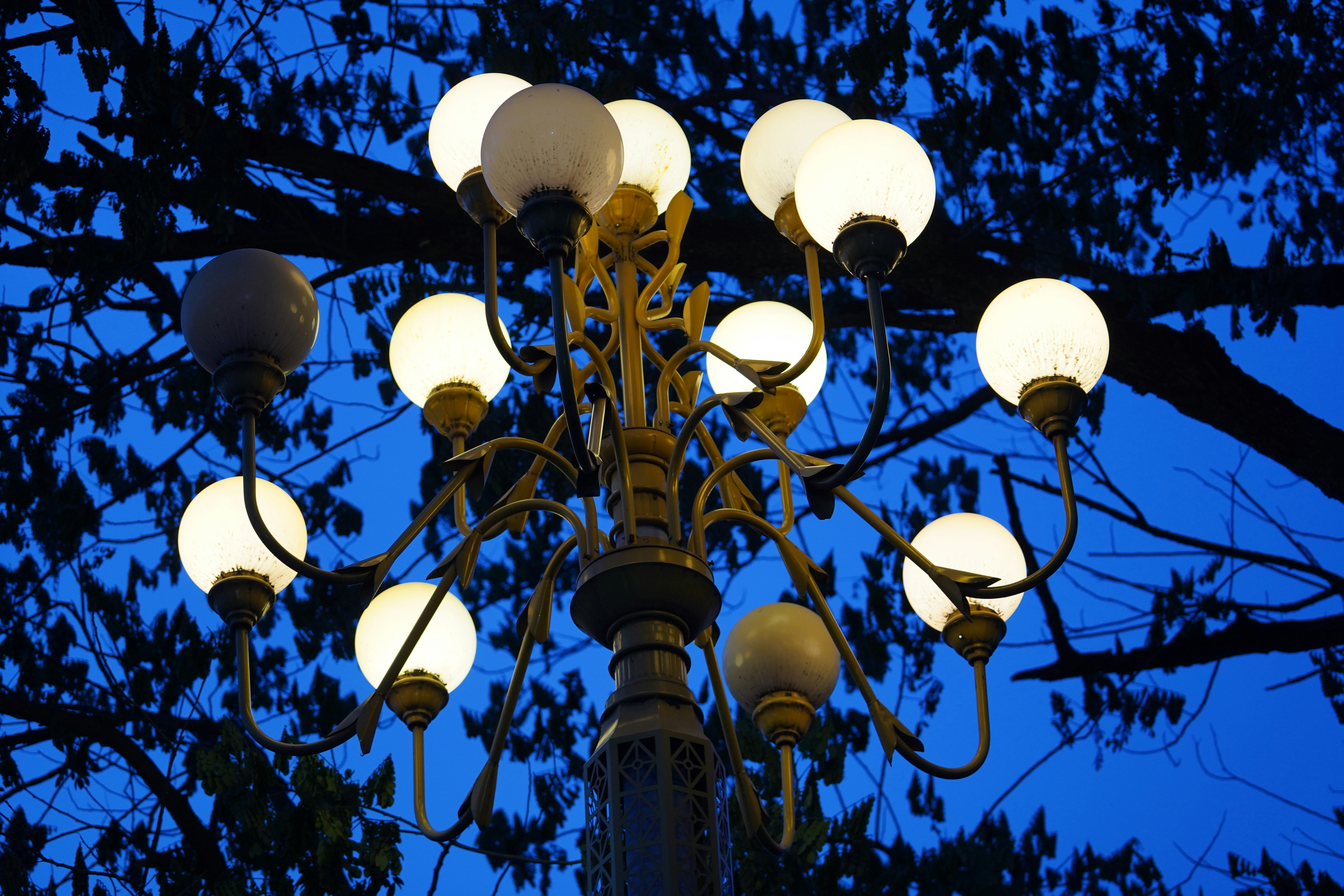Luminous Crown: An Ornate Streetlamp Against a Velvet Evening Sky