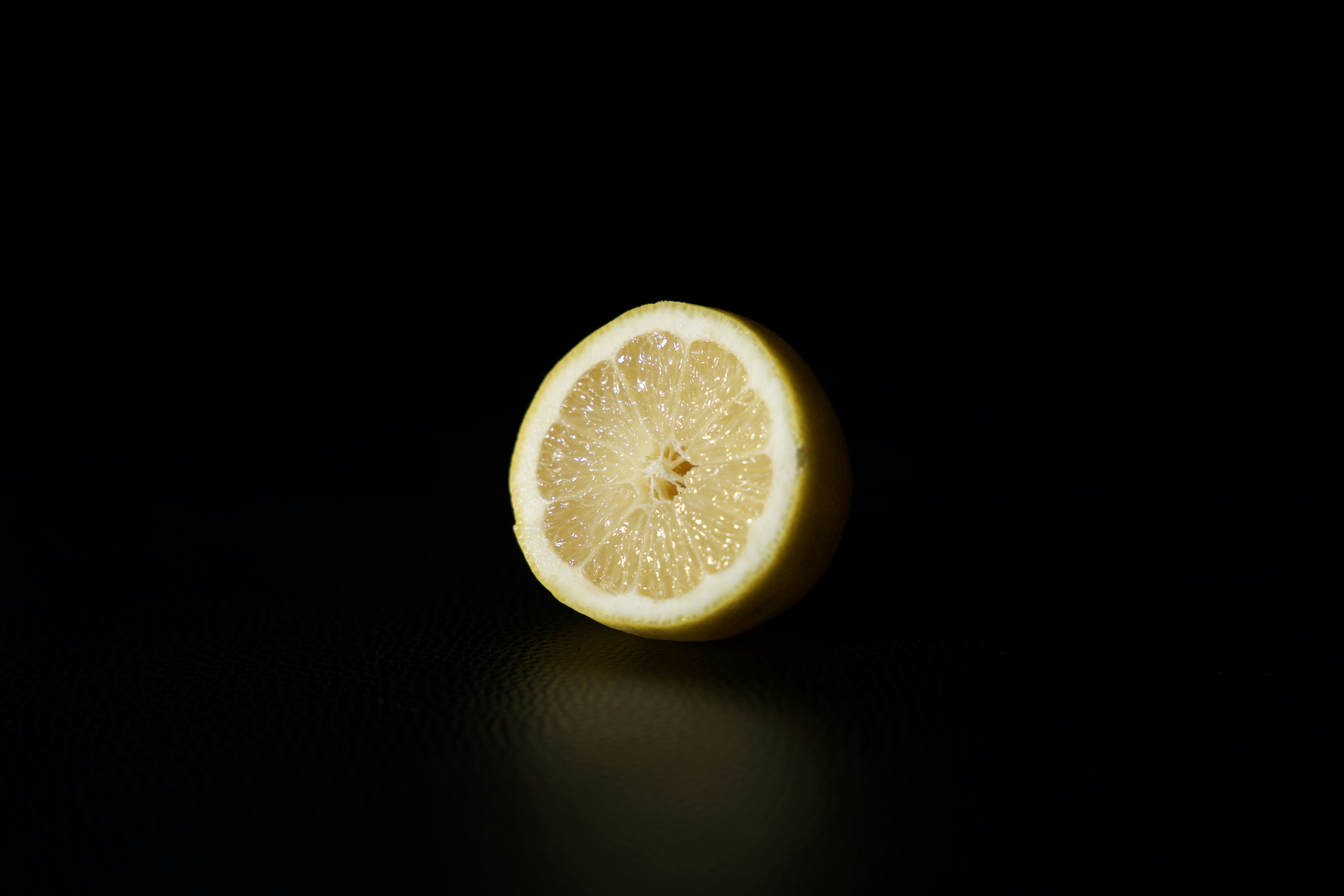 Lemon Half in Spotlight: Quiet Geometry on a Dark Stage