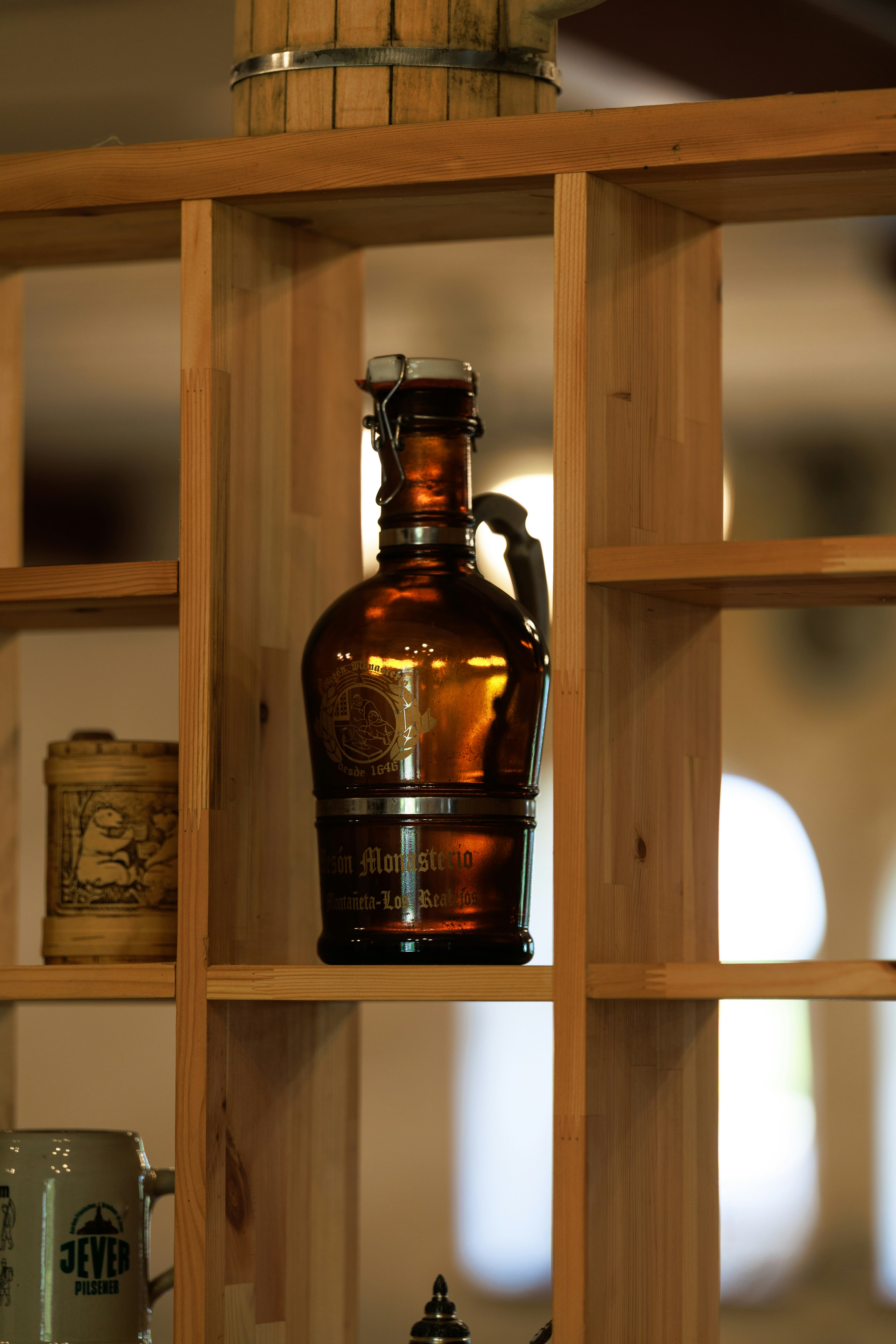 Amber Bottle Centered in Wooden Shelf Frame