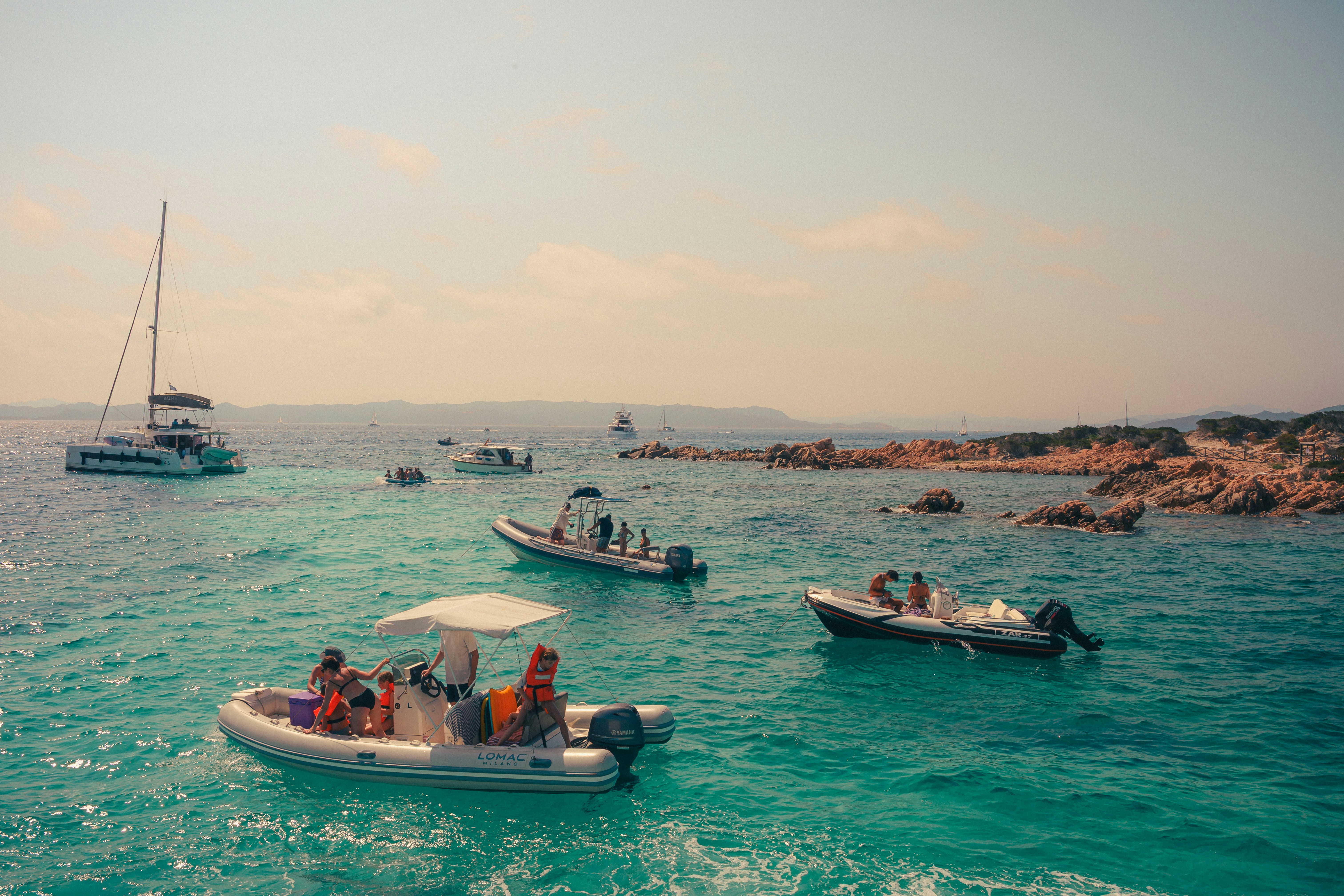 Turquoise Wake: Boats Scatter the Coastal Cove