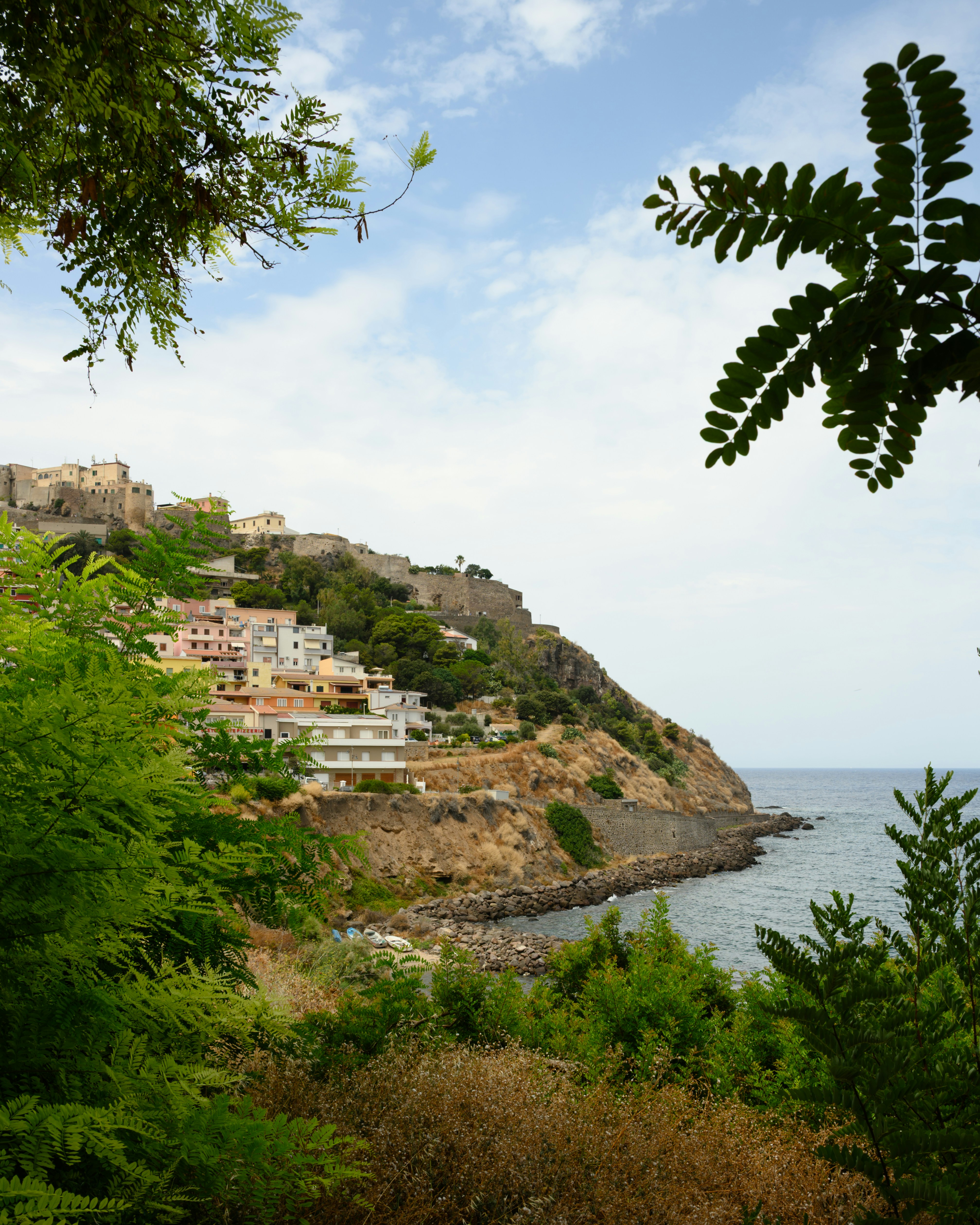Cliffside Village Framing: Coastal Buildings Descend Toward the Sea