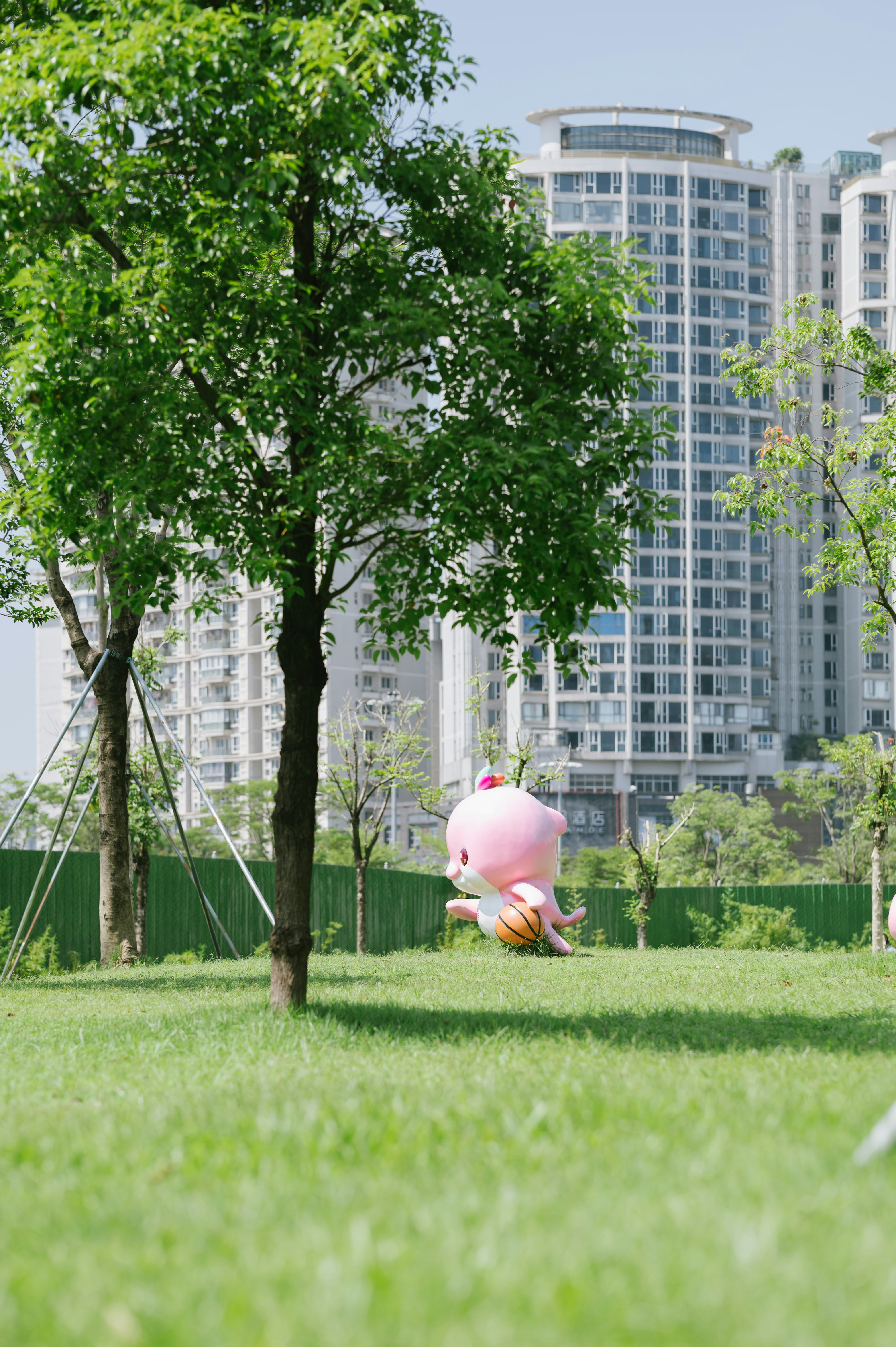 Pink Playground Bunny with Basketball in a Green City Park