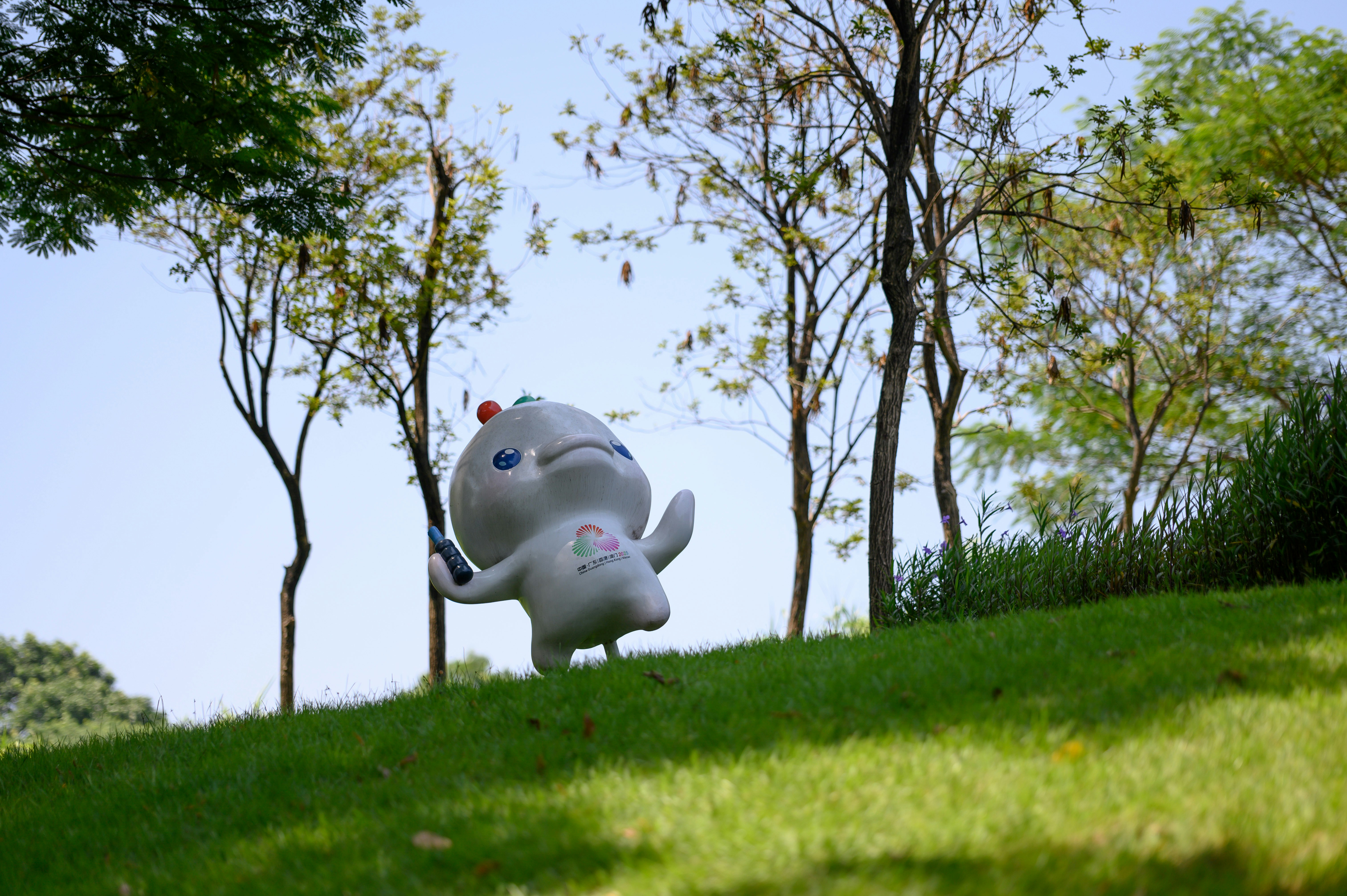 Playful mascot on a sunlit grassy slope