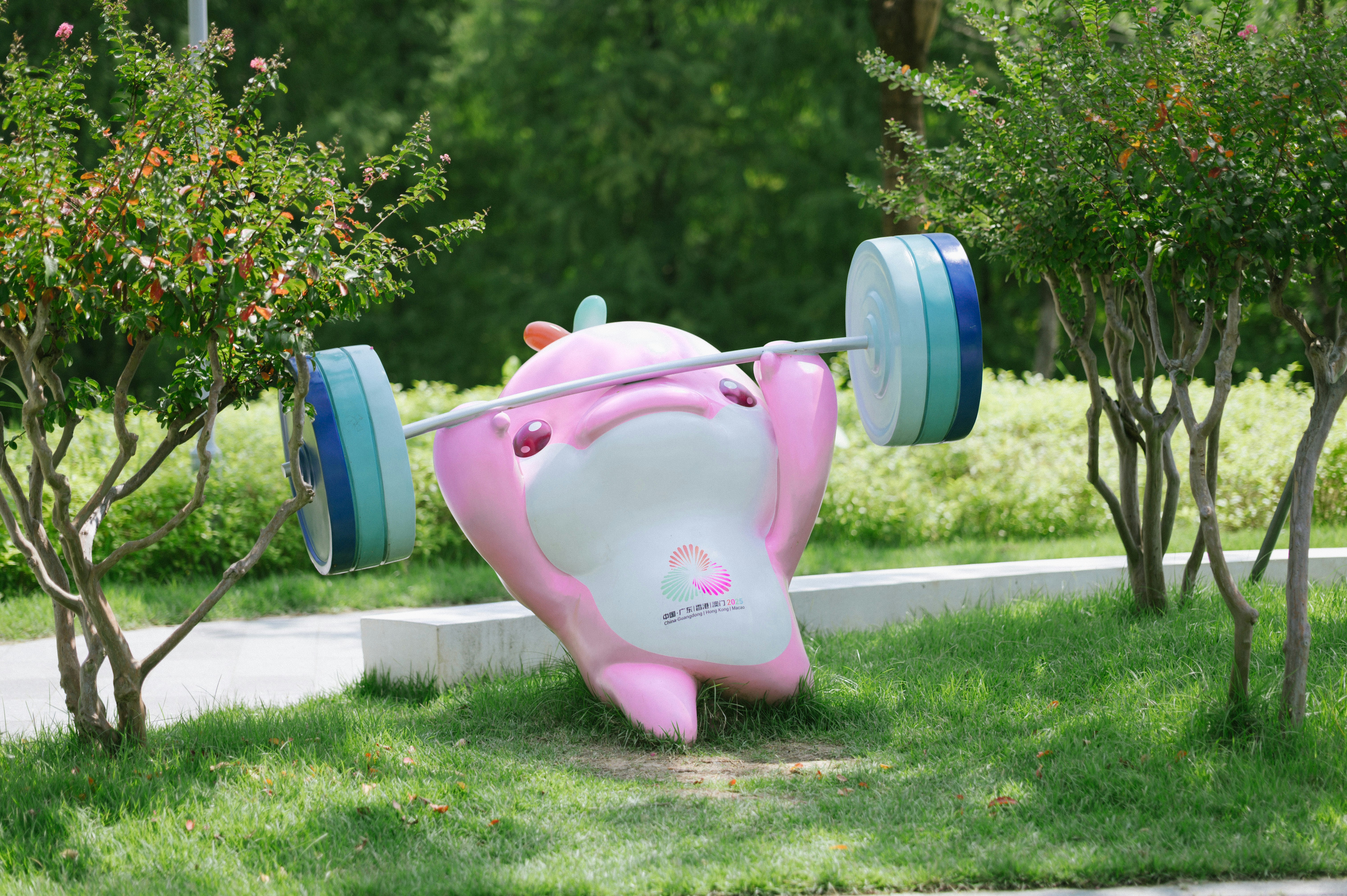 Tiny Titan: A Pink Weightlifter Sentinel in the Park