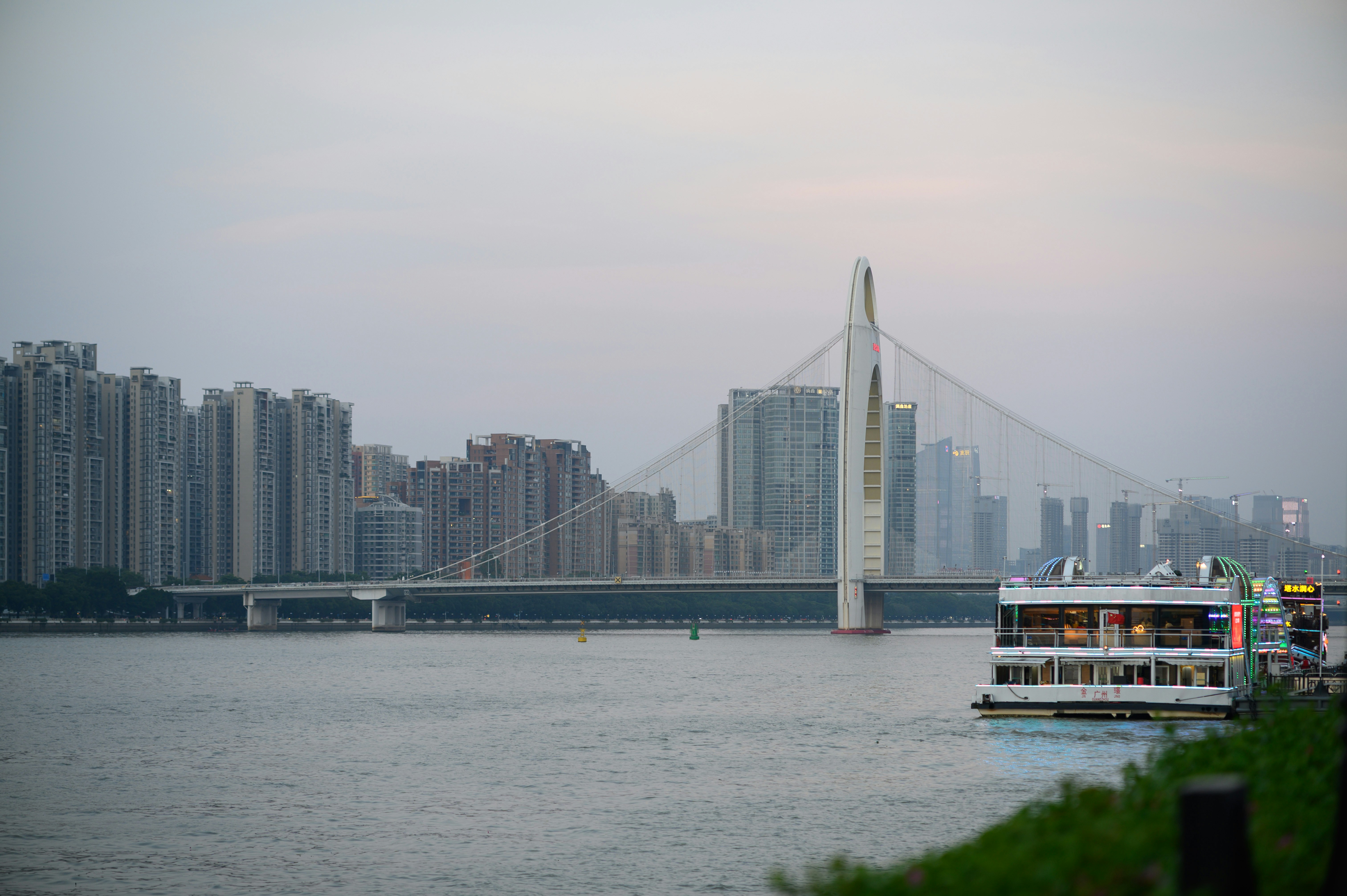 Riverfront Skyline and Cable-Stayed Bridge at Dusk