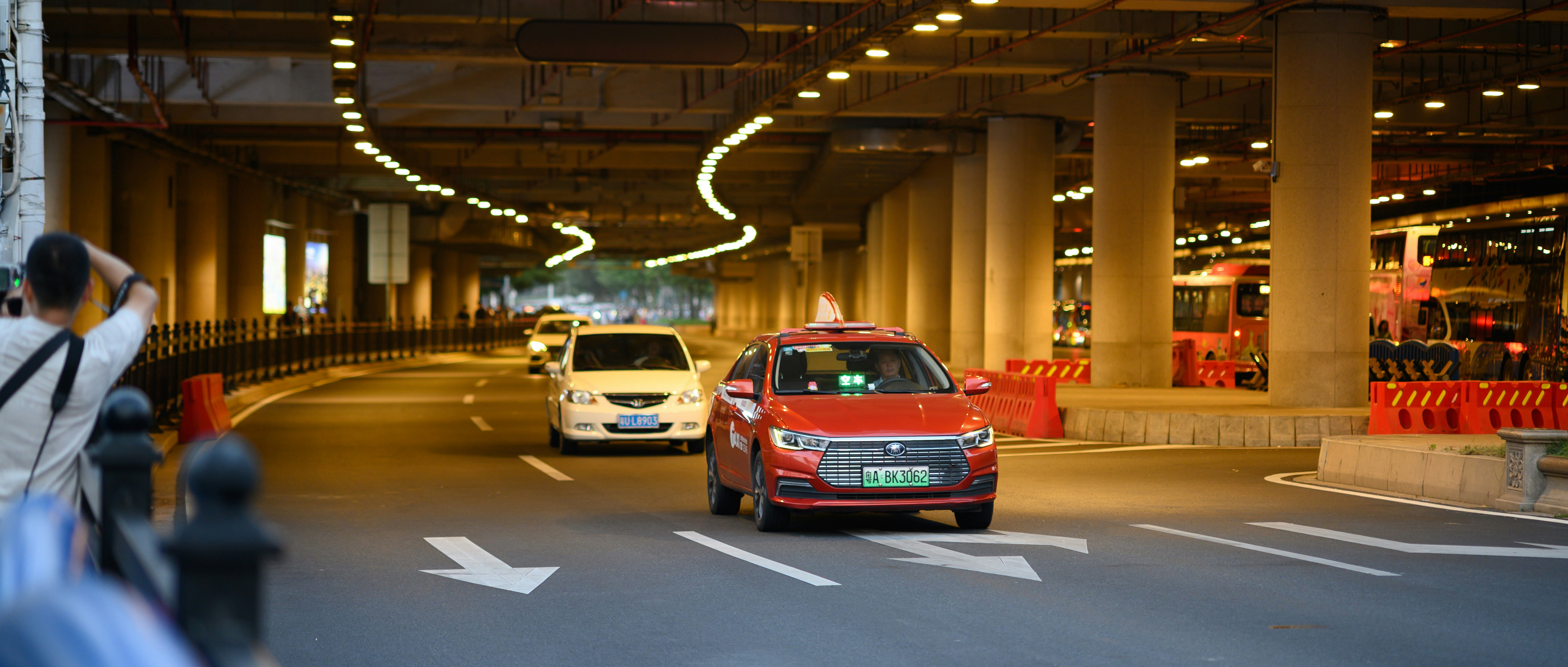 Red Sedan Leads the Curved Corridor