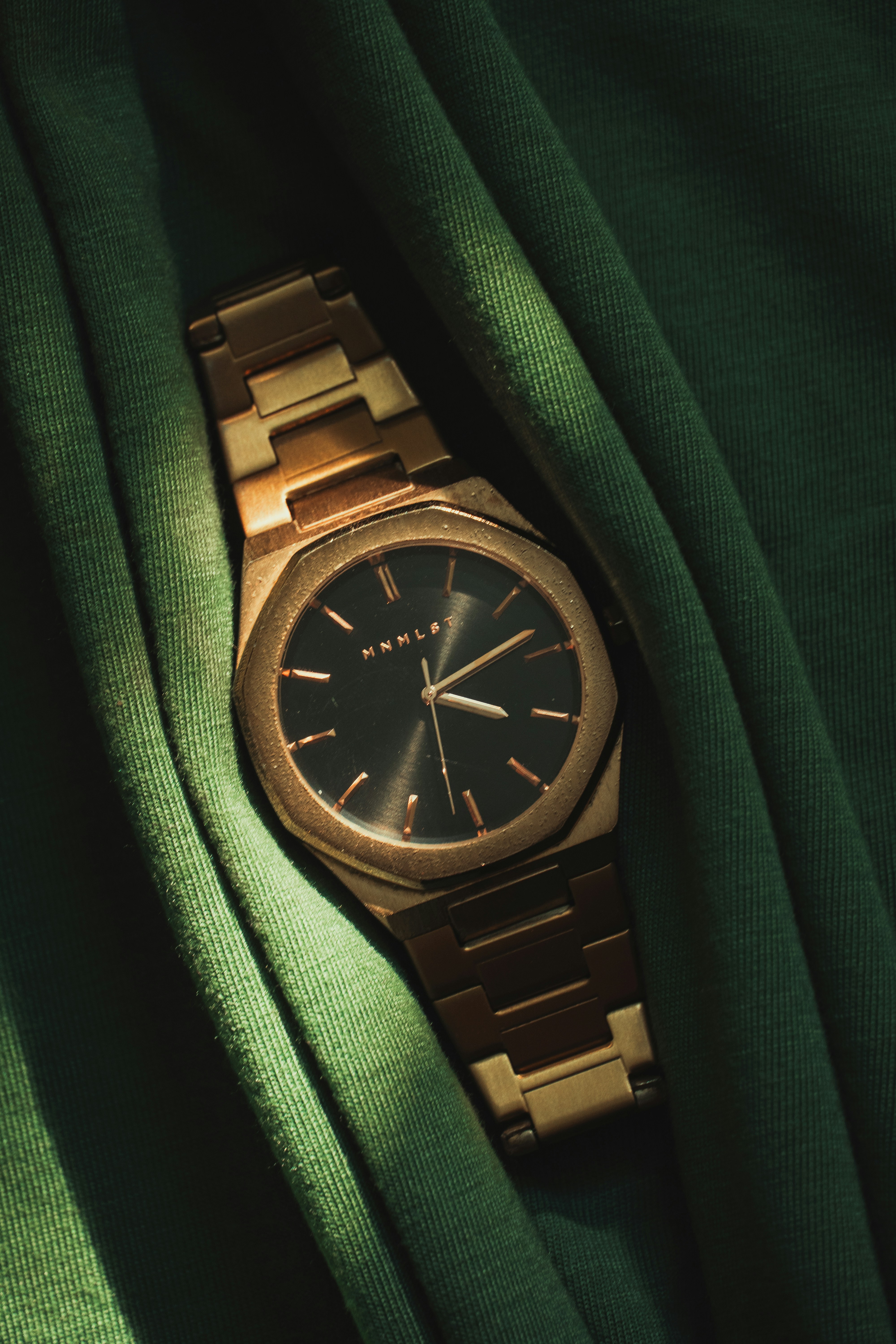 Emerald Veil: A Rich Timepiece Nestled in Fabric Folds