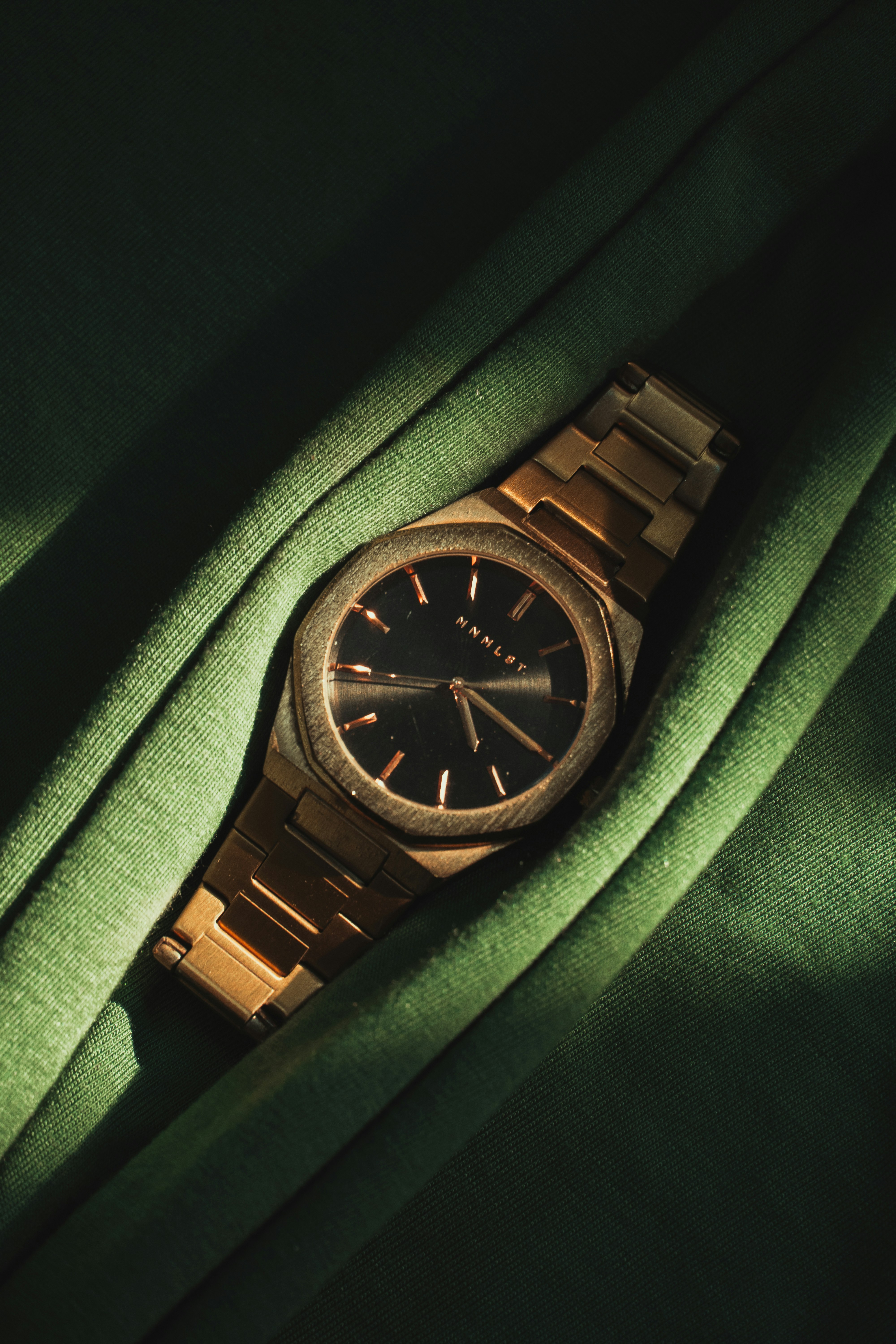 Gold-Toned Wristwatch Nestled in Green Velvet Creases
