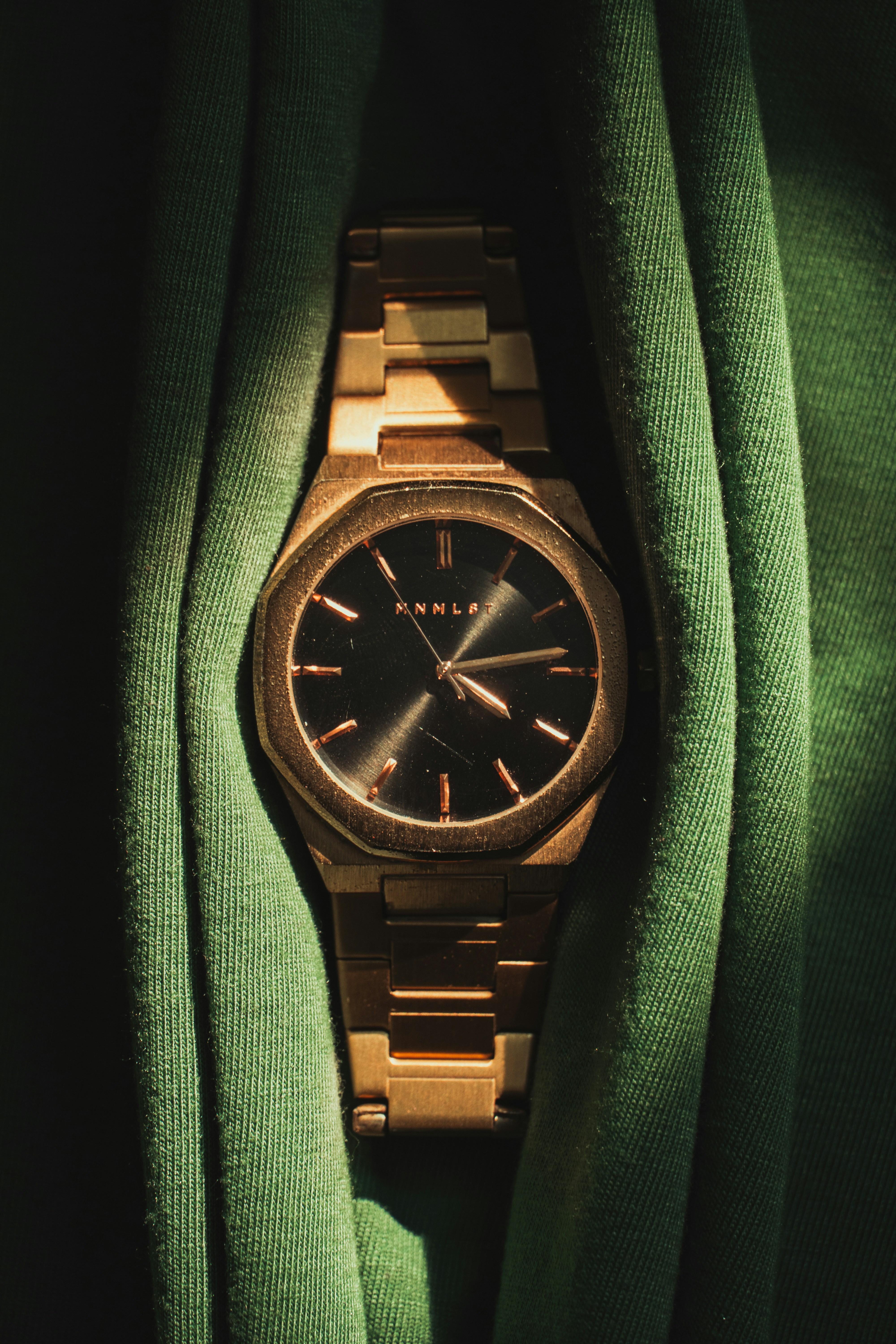 Golden Hands: A Watch Nestled in Velvet Green
