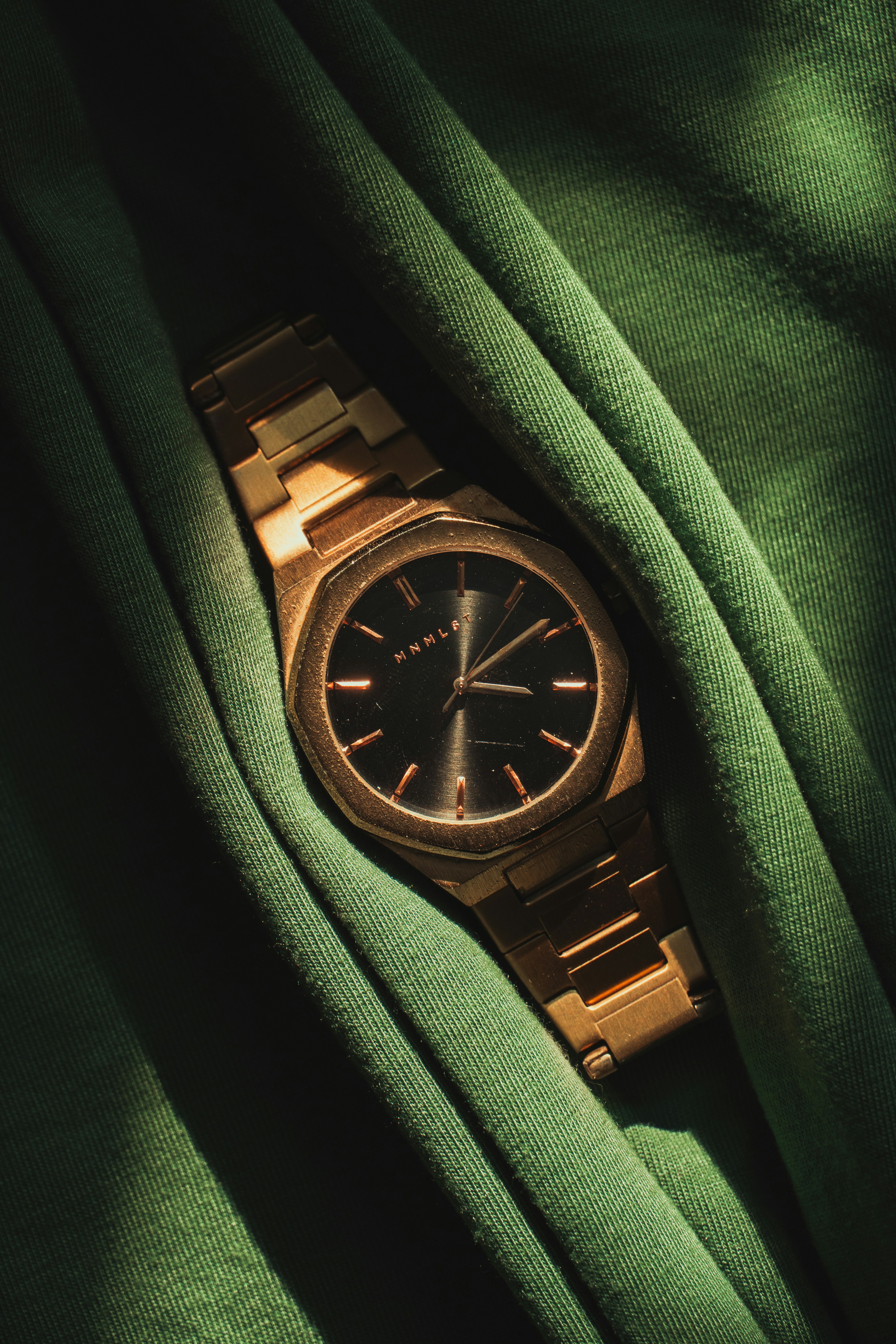 Emerald Fold: A Rose-Gold Watch Nestled in Velvet Green