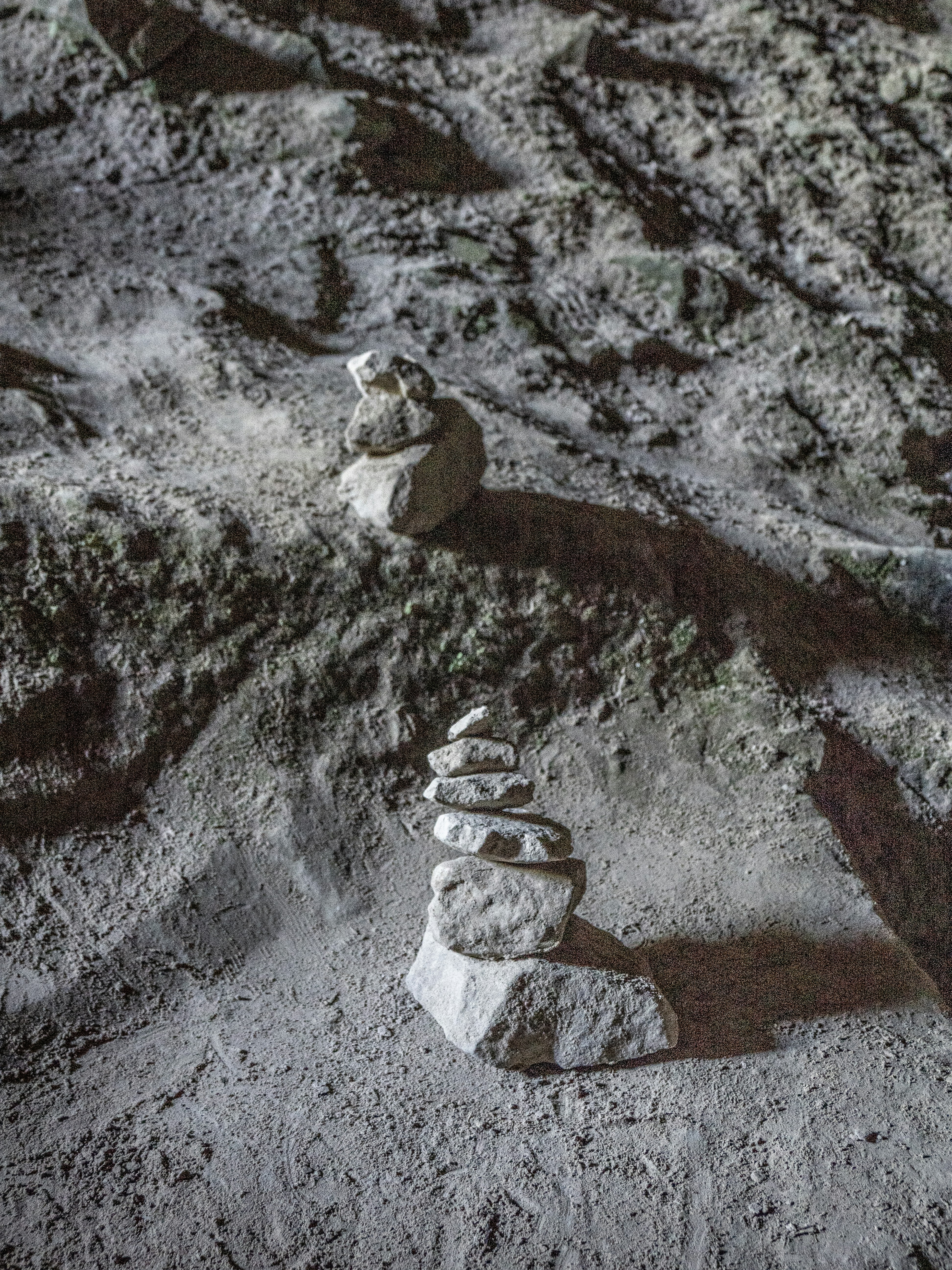 Balanced Stack: A Quiet Rock Formation in Dim Cave Light
