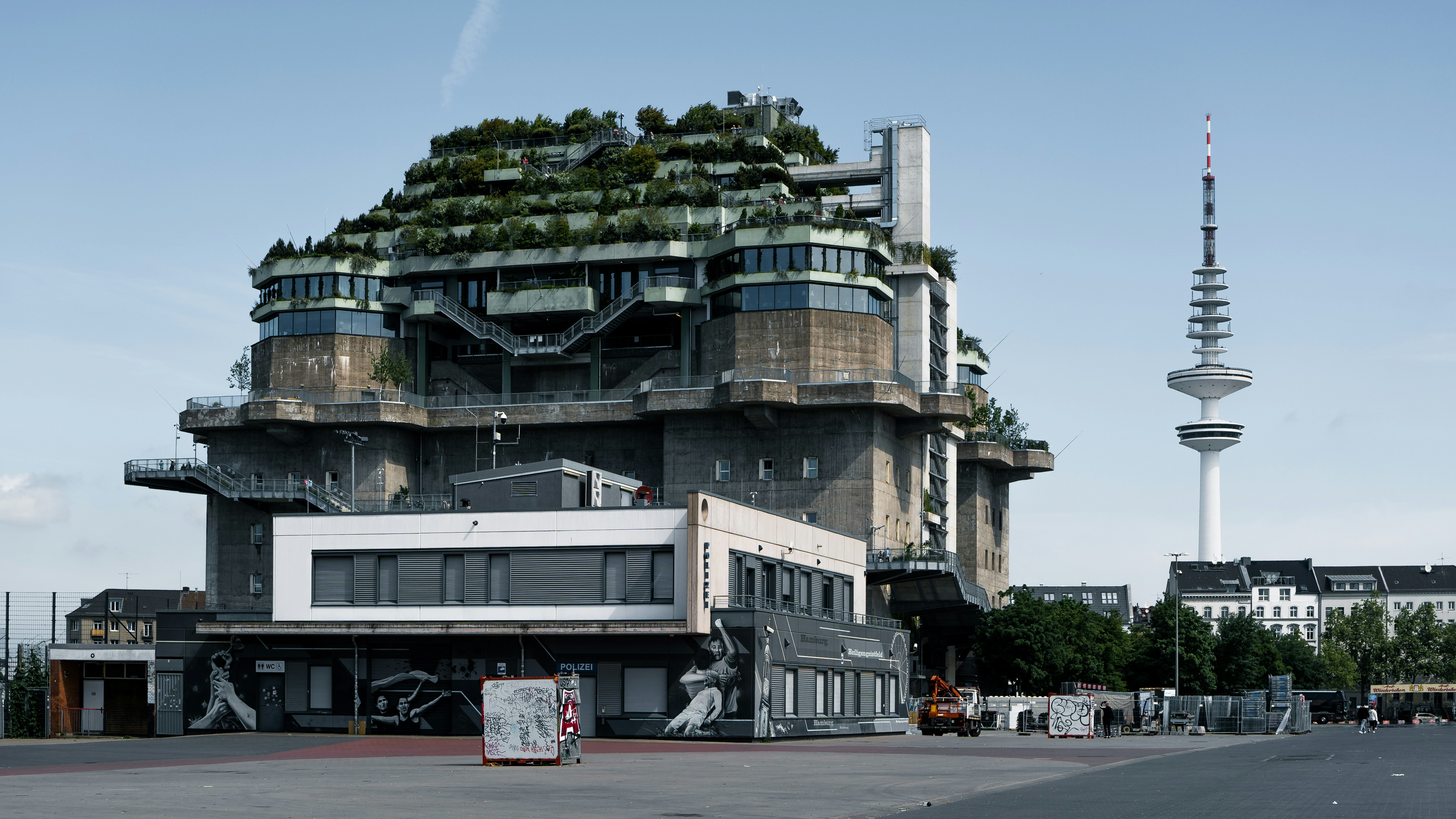 Vertical Monumental Architecture: A Concrete Overtop with Terraced Greenery and Tower