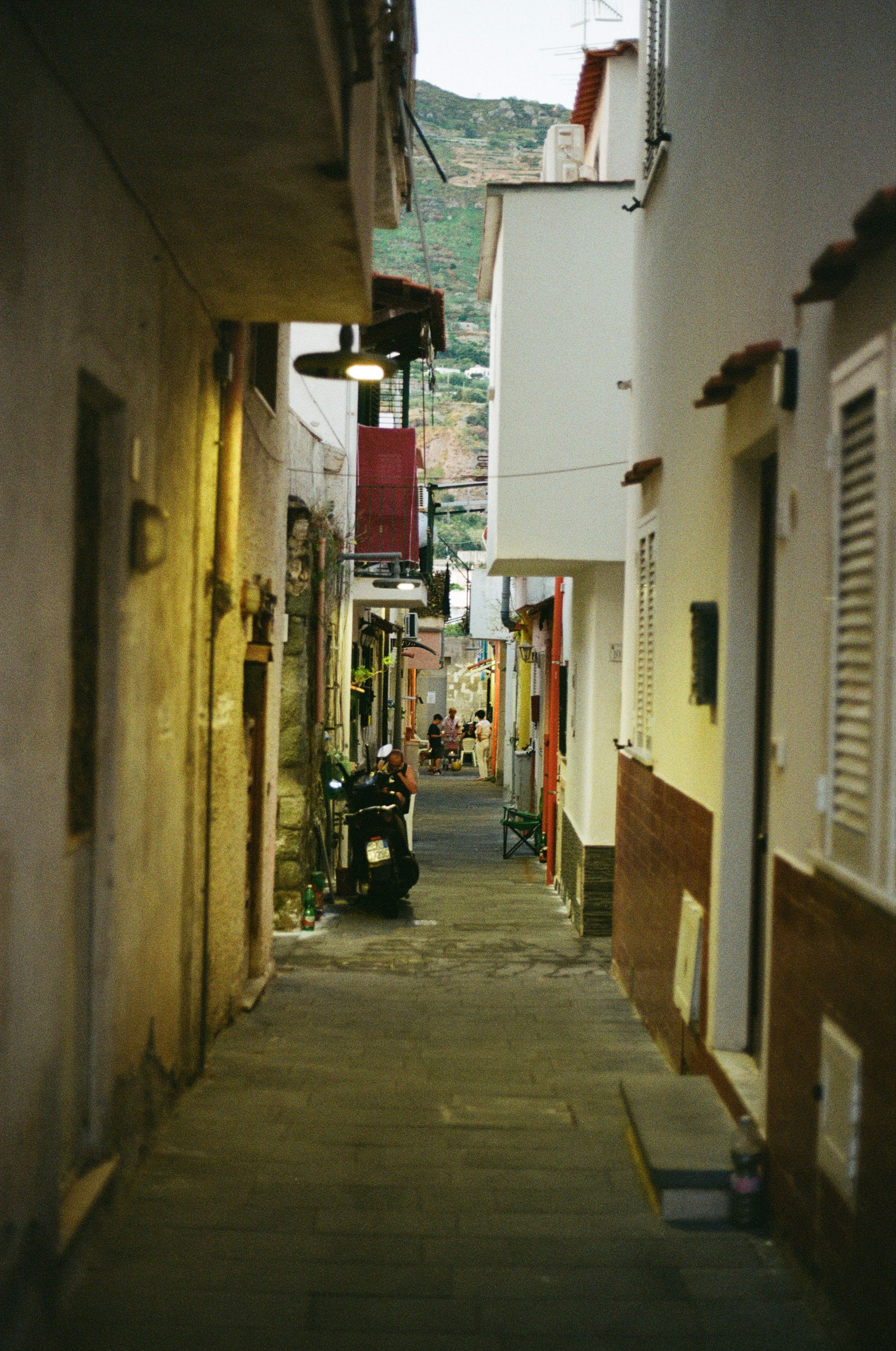 Narrow Calle of Quiet Motion: A Vespa Amid Warm Street Light