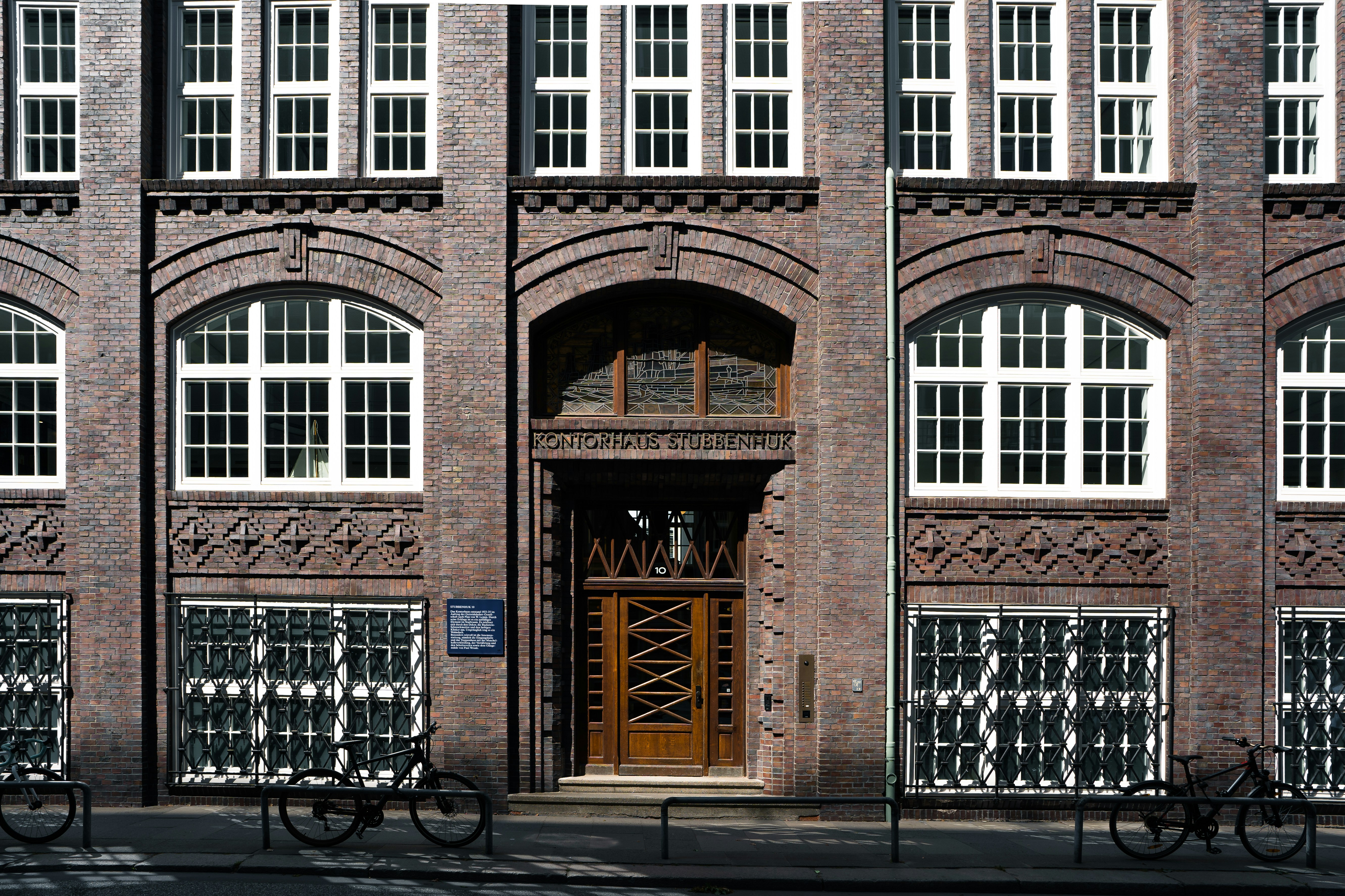 Brick Facade and Ironwork: Evening in Front of the City School
