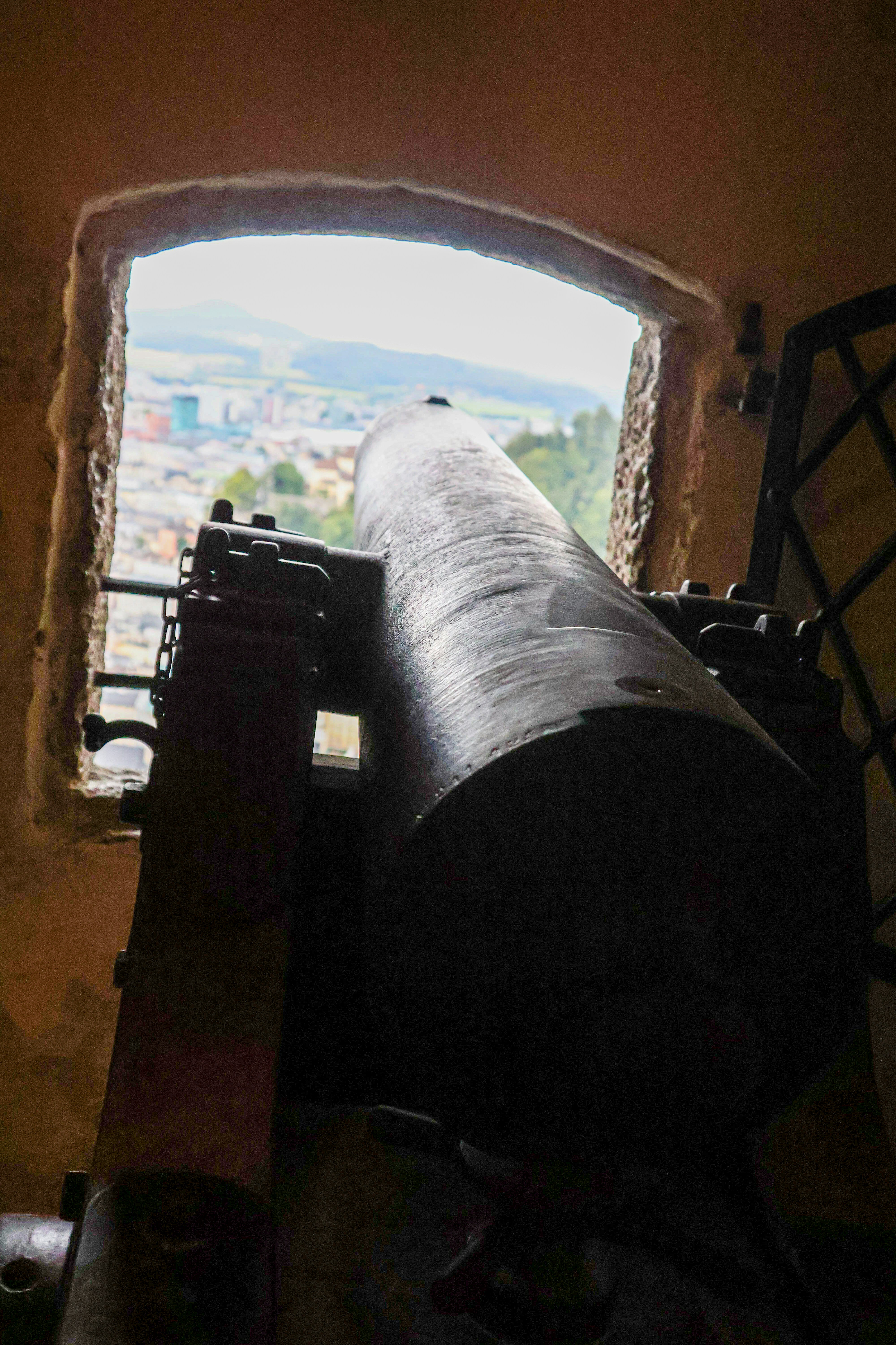 A Silent Gaze: An Old Cannon Overlooking a Distant Town