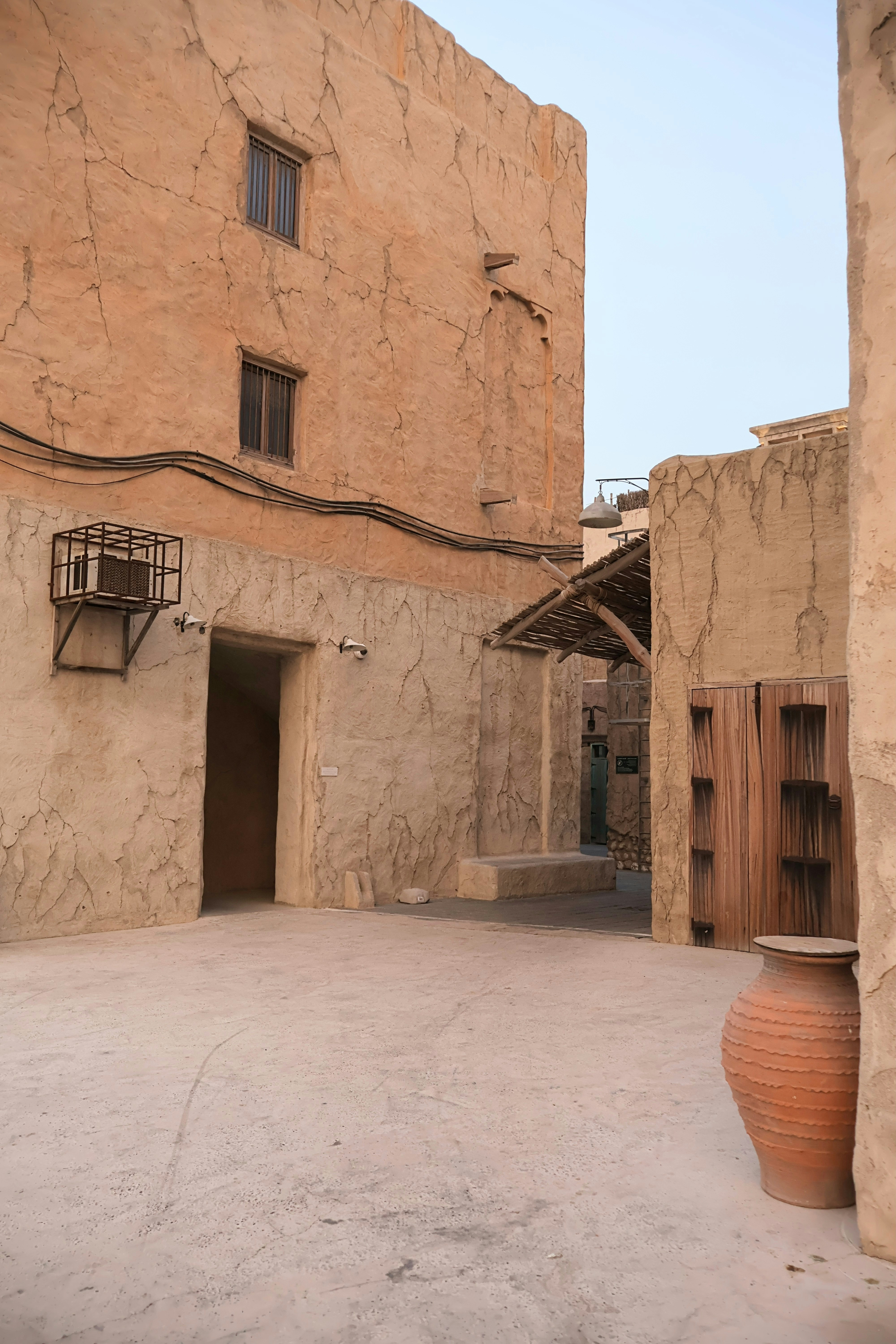 Mud‑washed Courtyard Amid Cracked Walls