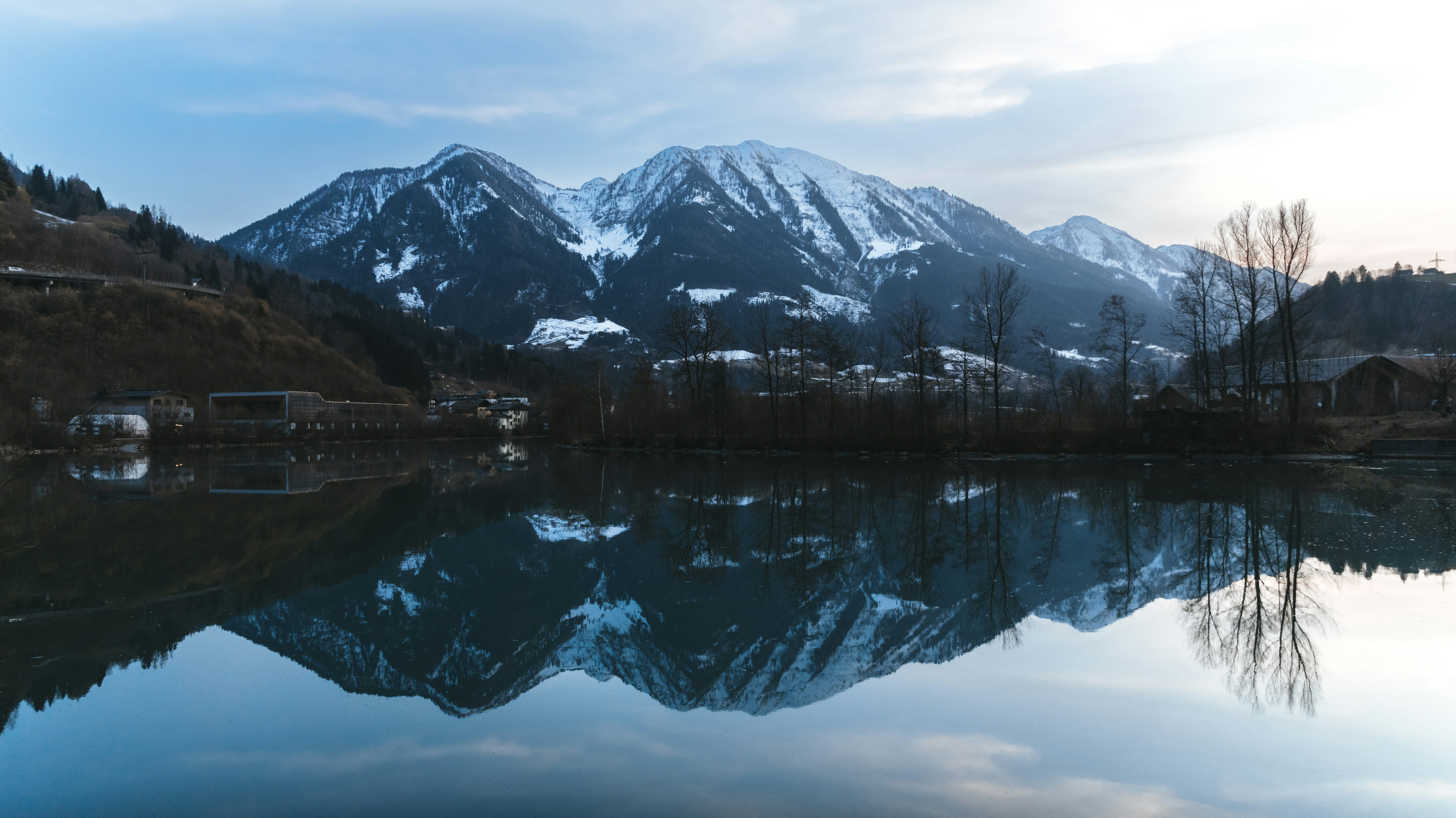 Mirror Summit: Snow-Capped Peaks Reflect in a Tranquil Alpine Lake
