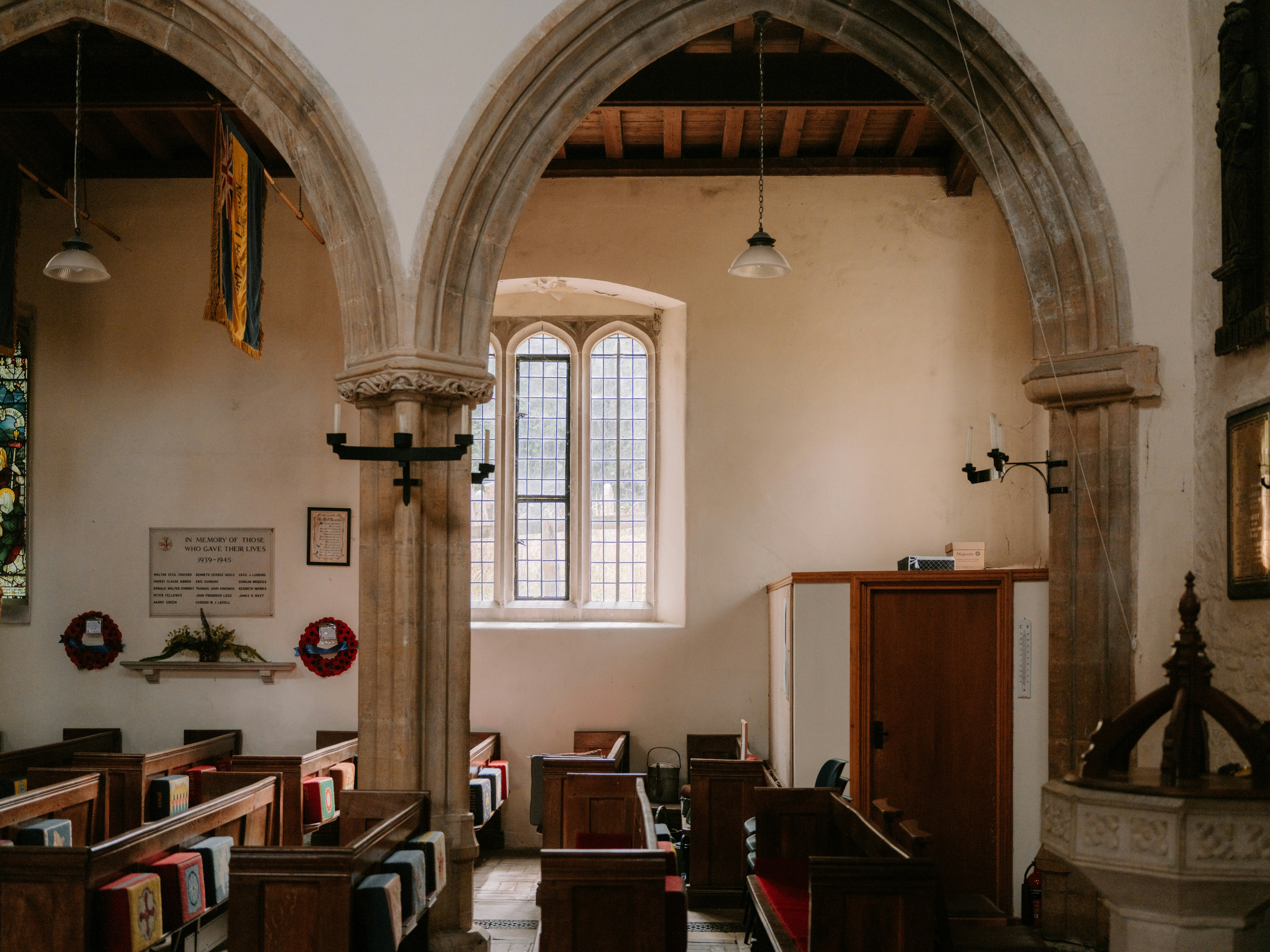 Quiet Choir Hall: Stained Glass, Arches, and Wooden Pews