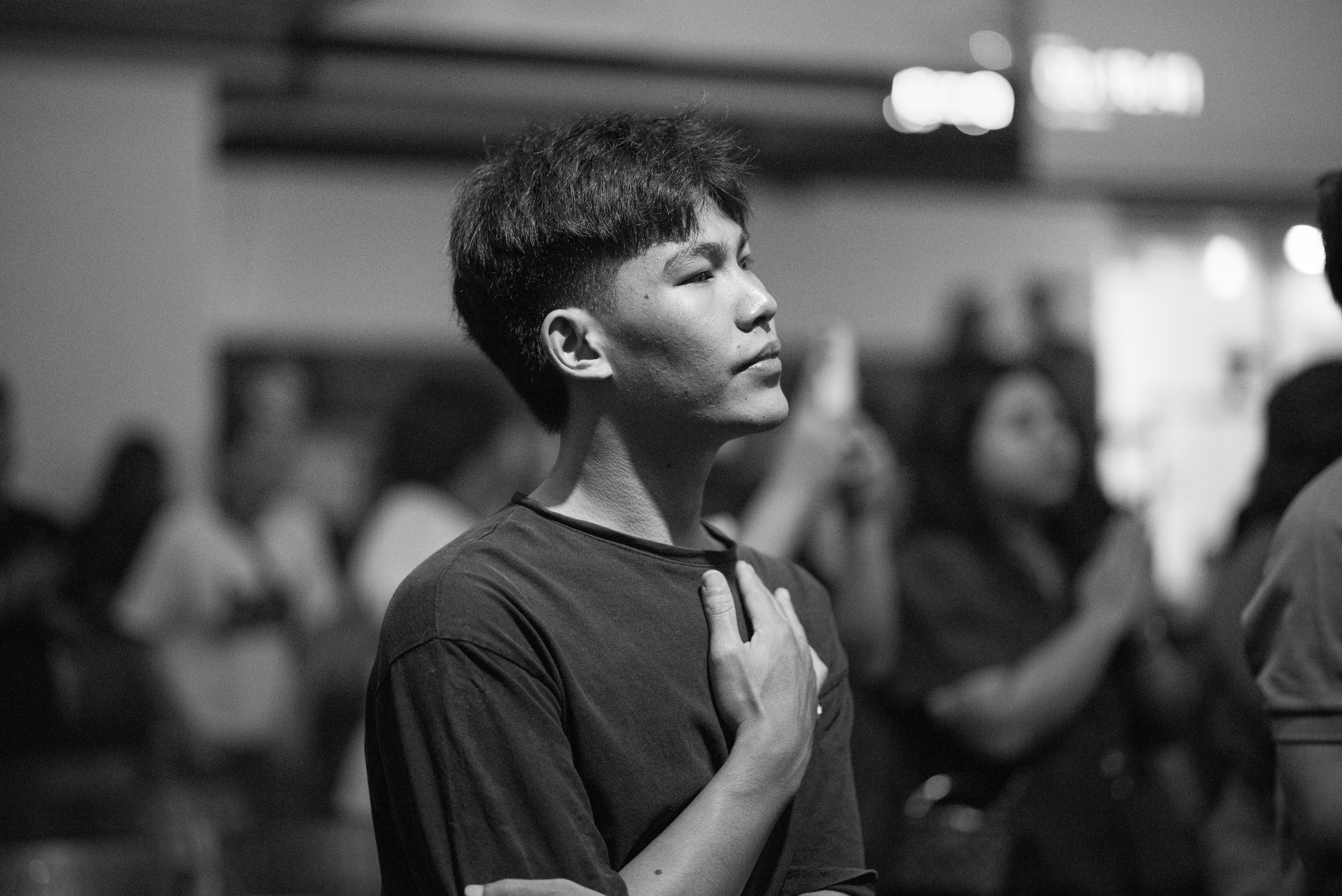 Contemplation in the Crowd: A Quiet Moment in Black and White
