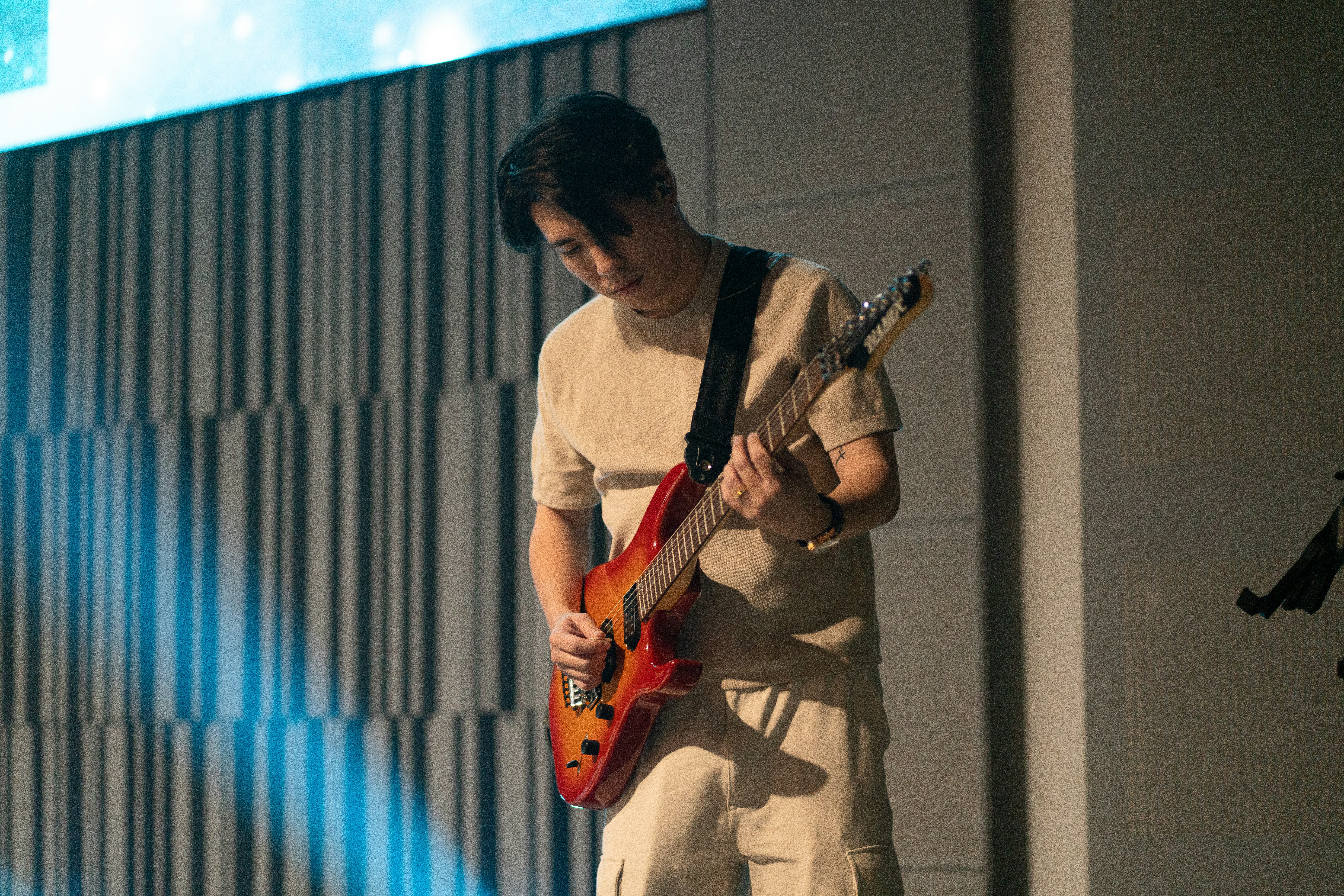 Sunlit Strings: A guitarist lost in the melody on stage