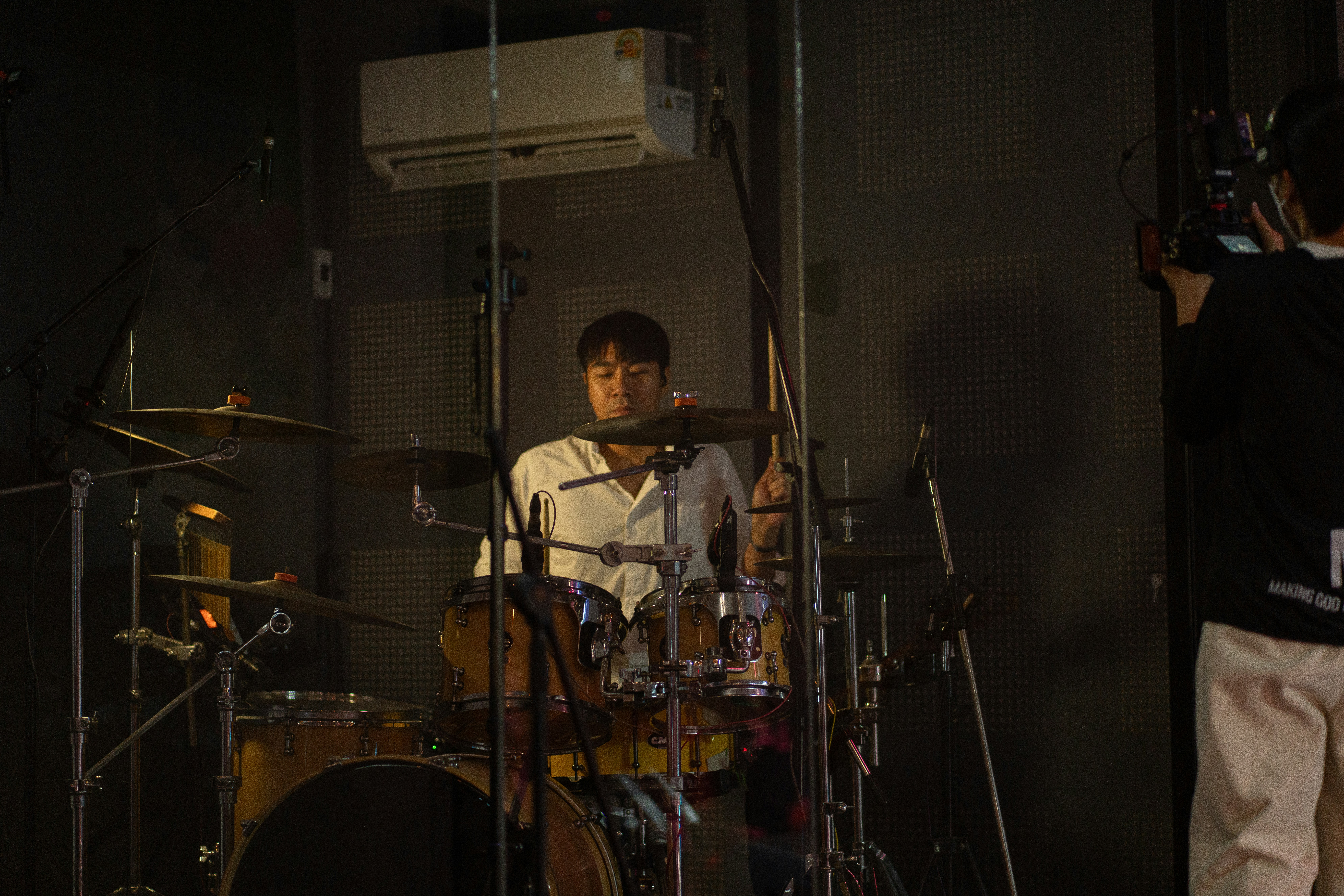 Midnight Groove: Drummer Anchored in the Studio Hue