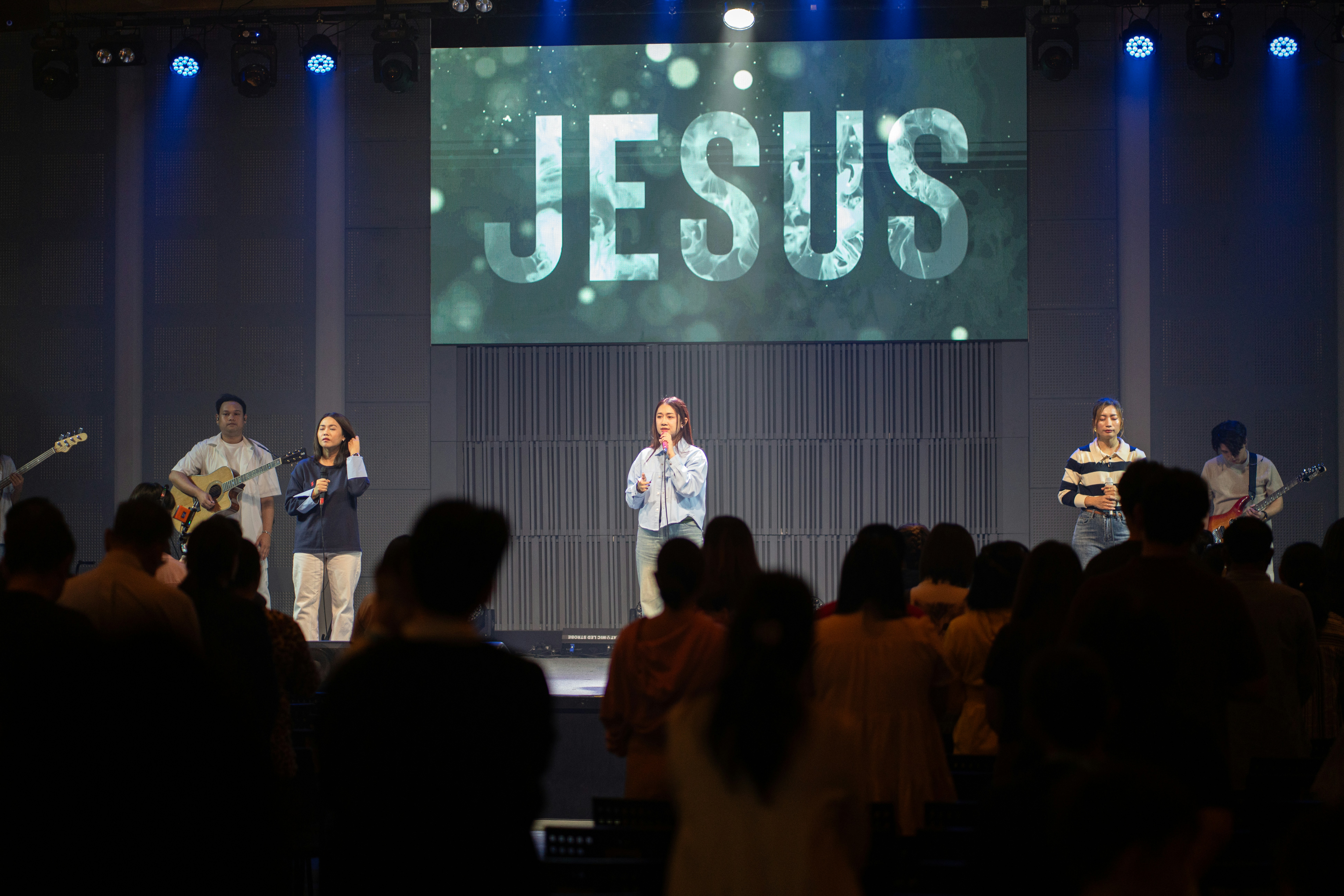 Stage Mirage: A Worship Band Under a Glassy Screen