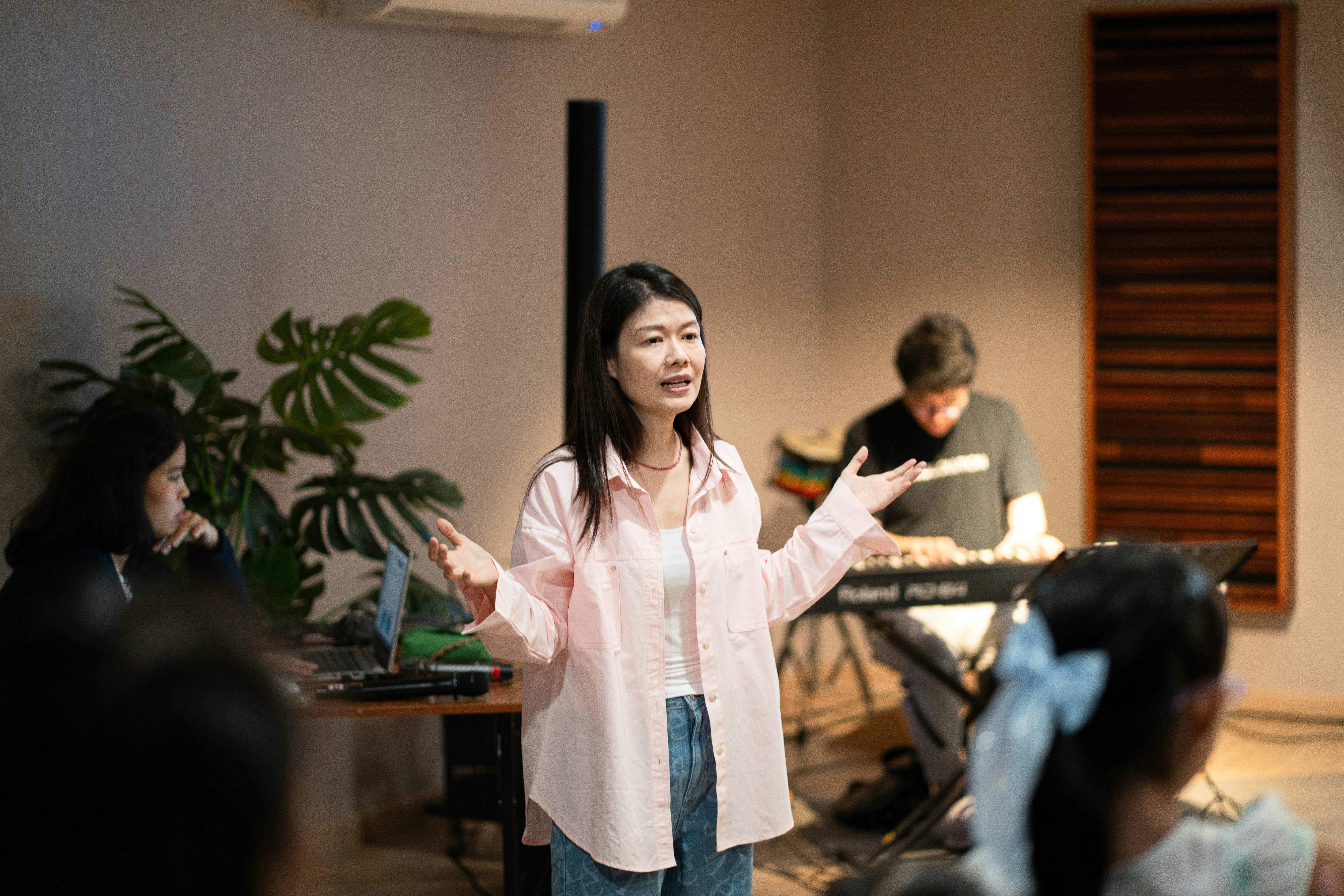 Center Stage: A Vocalist Leads an Intimate Rehearsal in Soft Studio Light