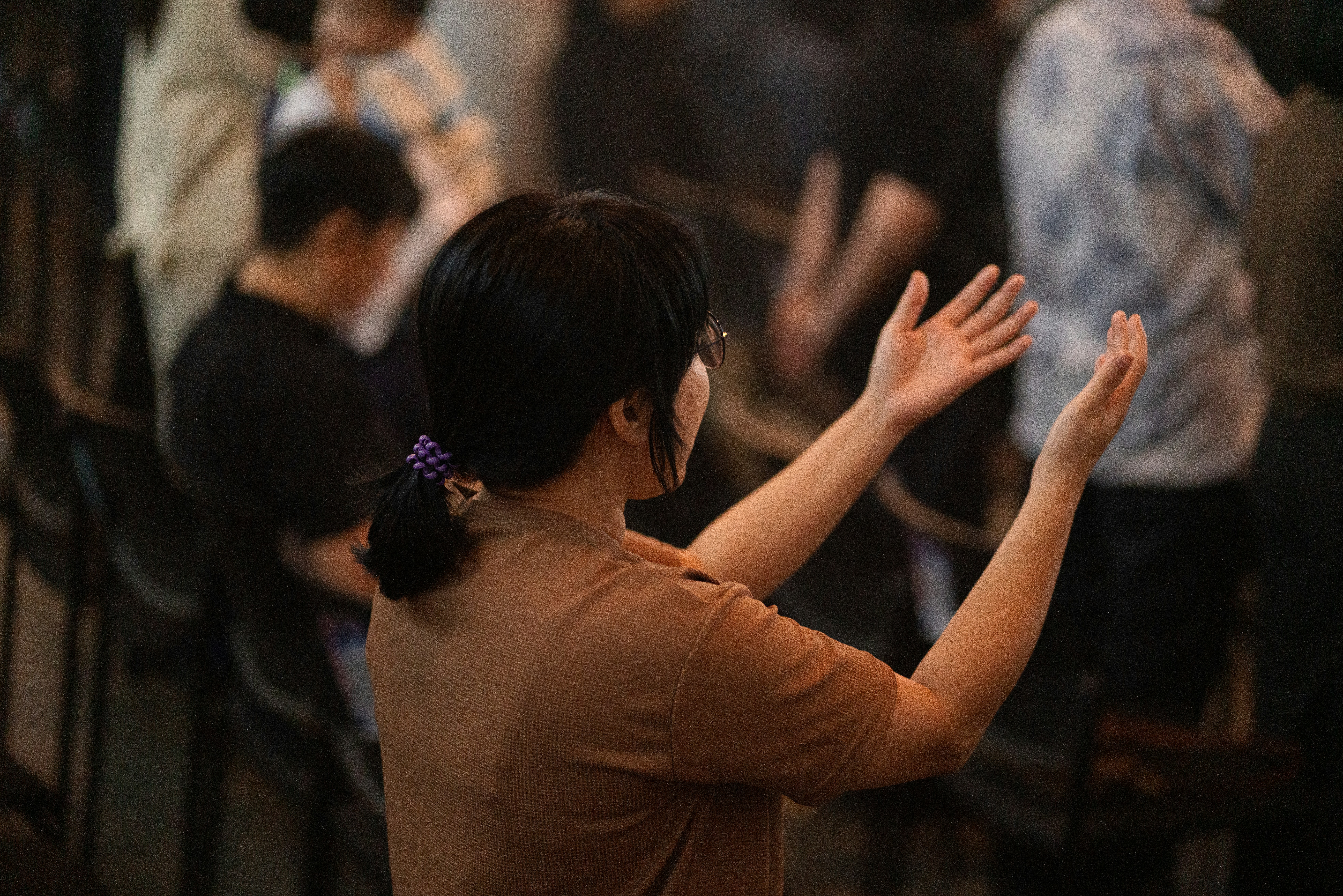 Hands in Motion: A Moment of Expression in a Crowded Room