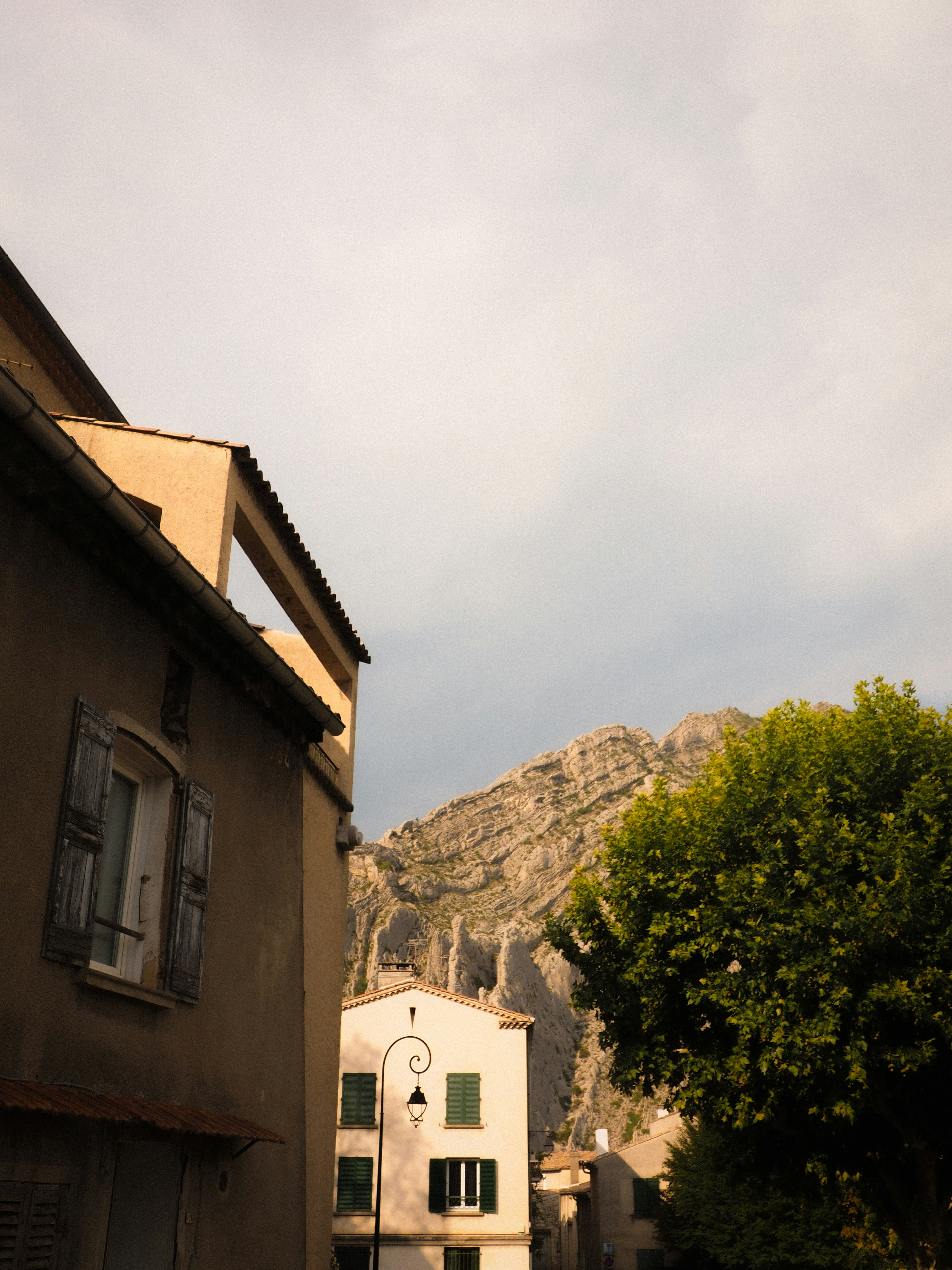 Sunlit Village Facade Beneath Alpine Sky