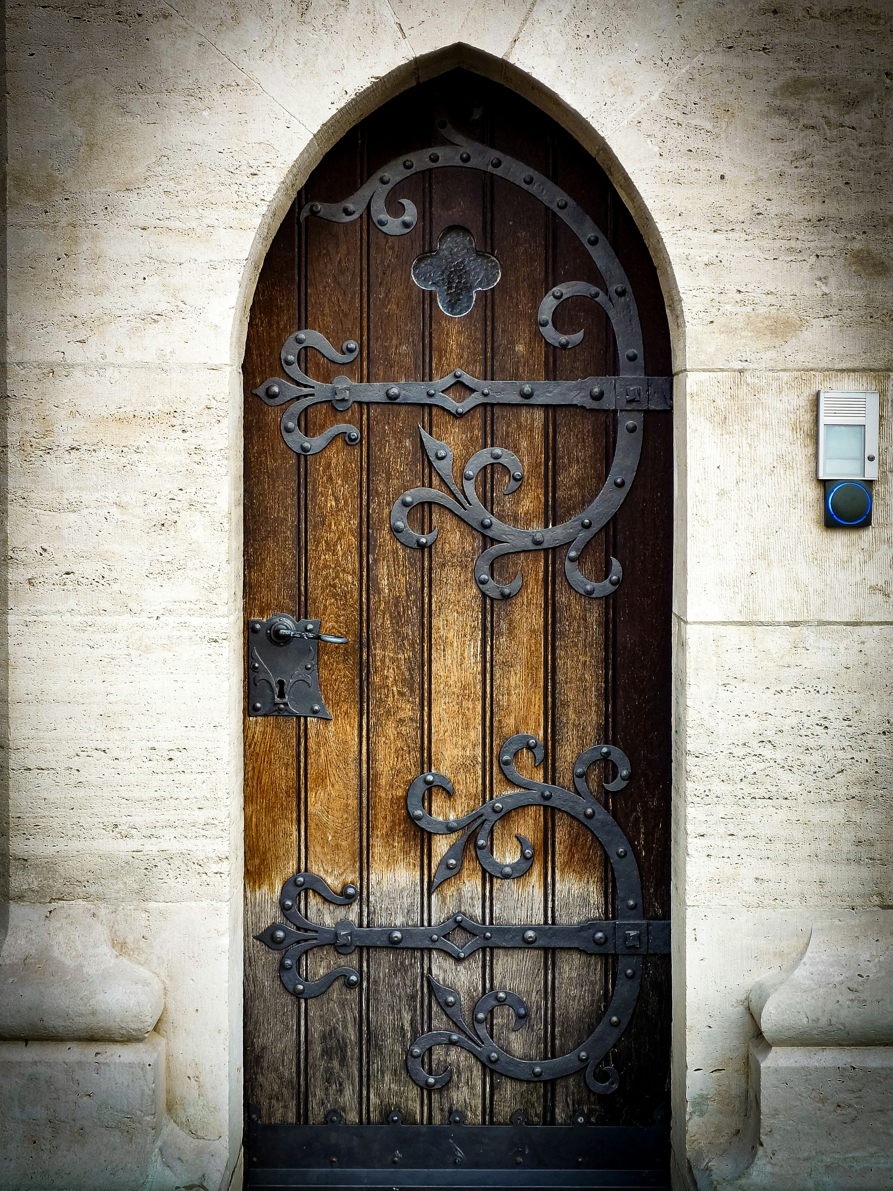 Heritage Door: Timeworn Wood Beneath Ironwork