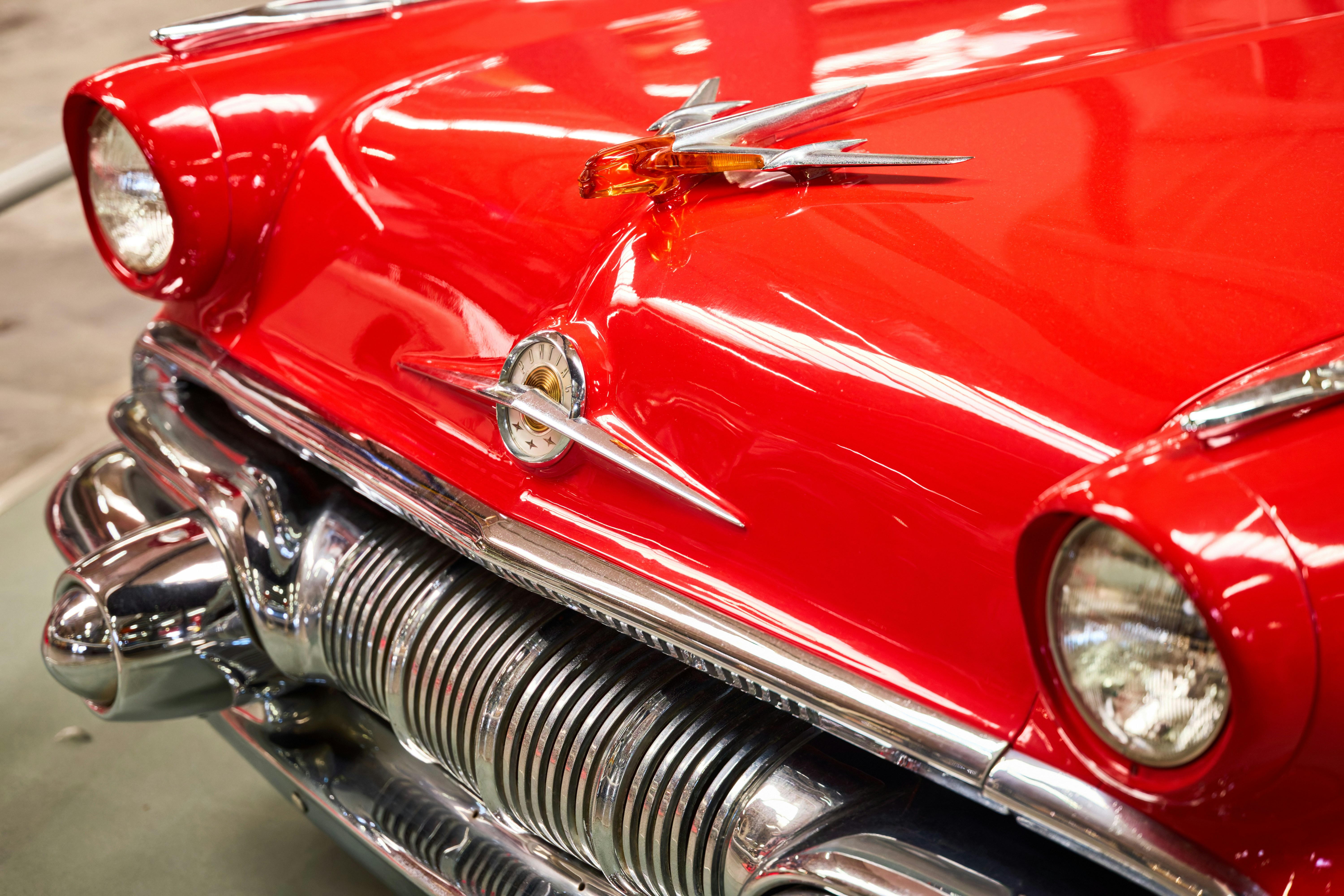 Chrome Grin: A Vintage Red Chevy’s Gleaming Front