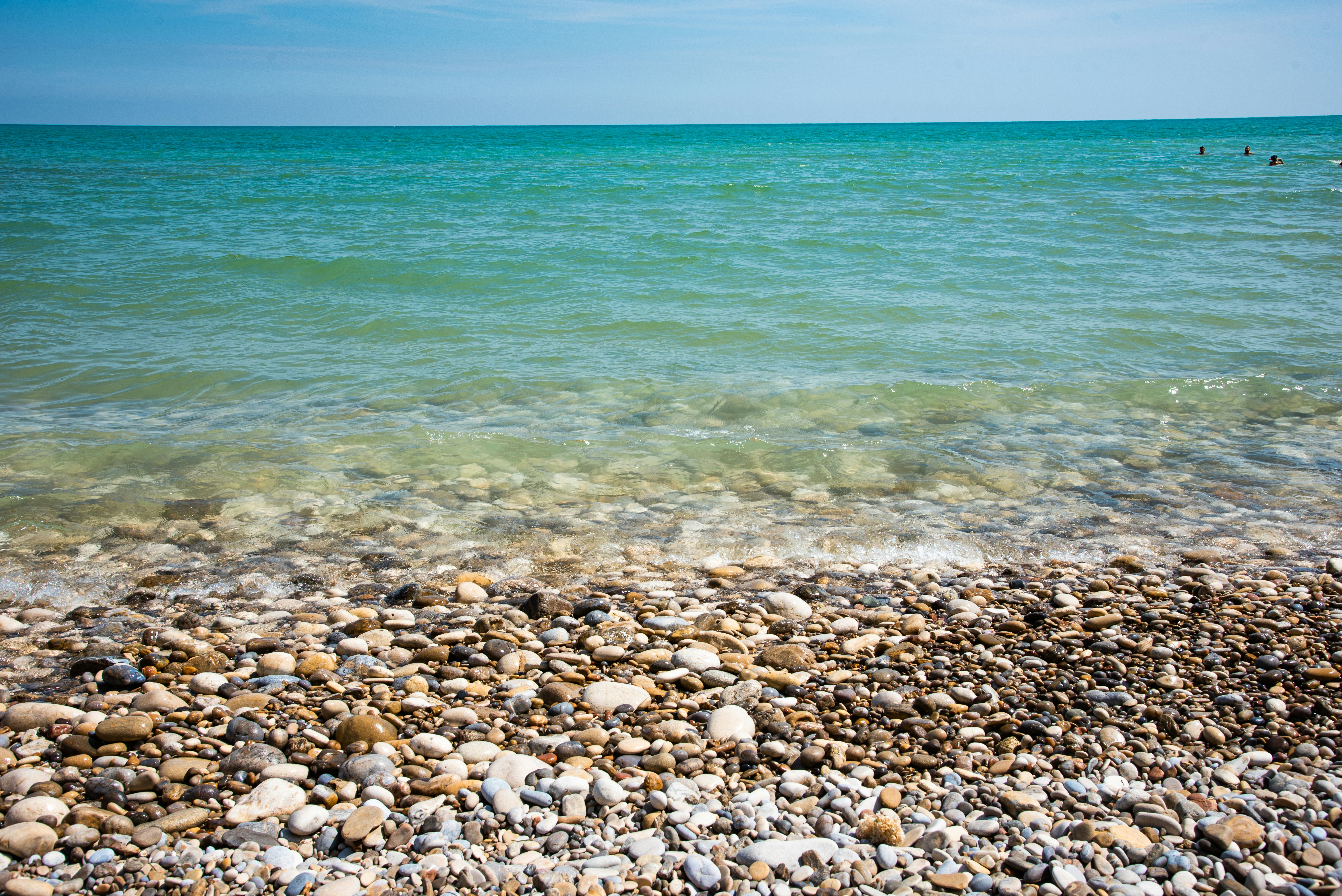Pebble Mosaic meets turquoise sea horizon