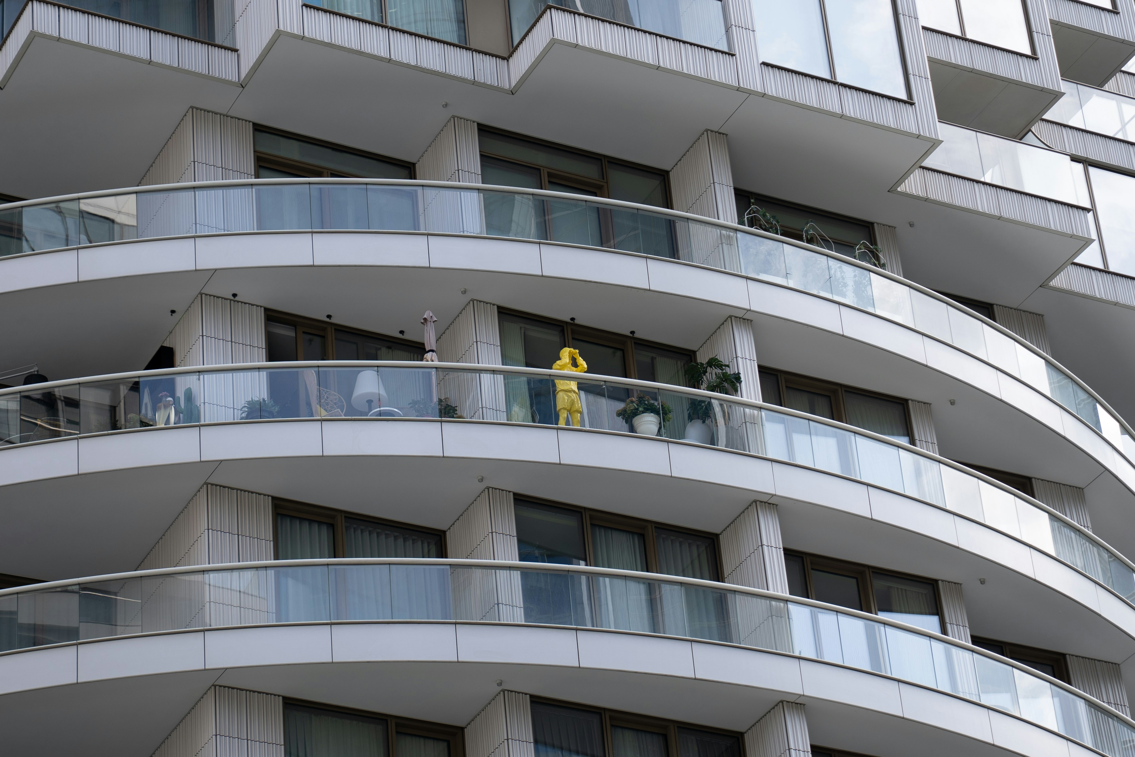 Yellow-Robed Figure on the Curved Balcony