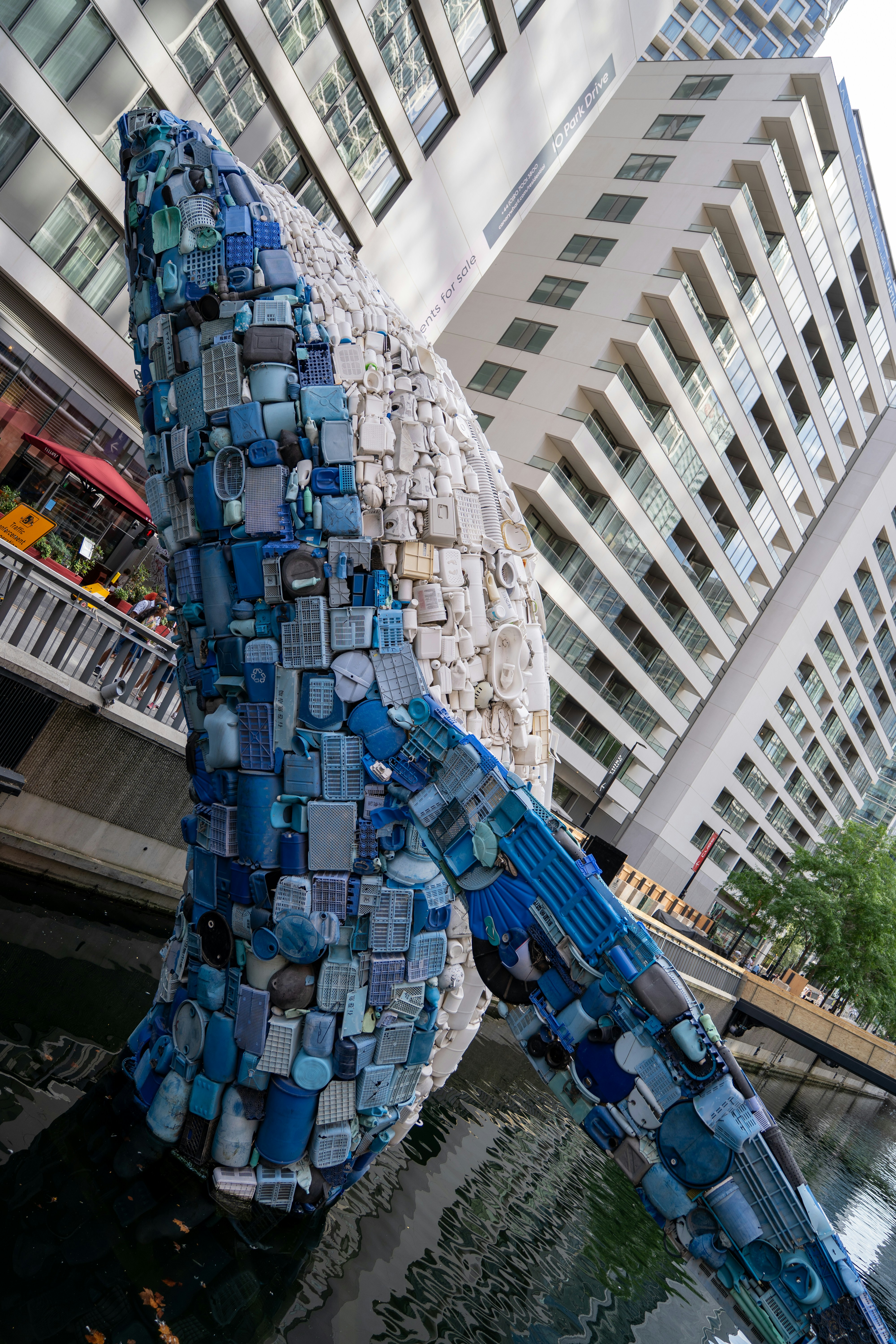 Recycled Giant: A Blue-and-White Whale Sculpture Rising Over the Canal