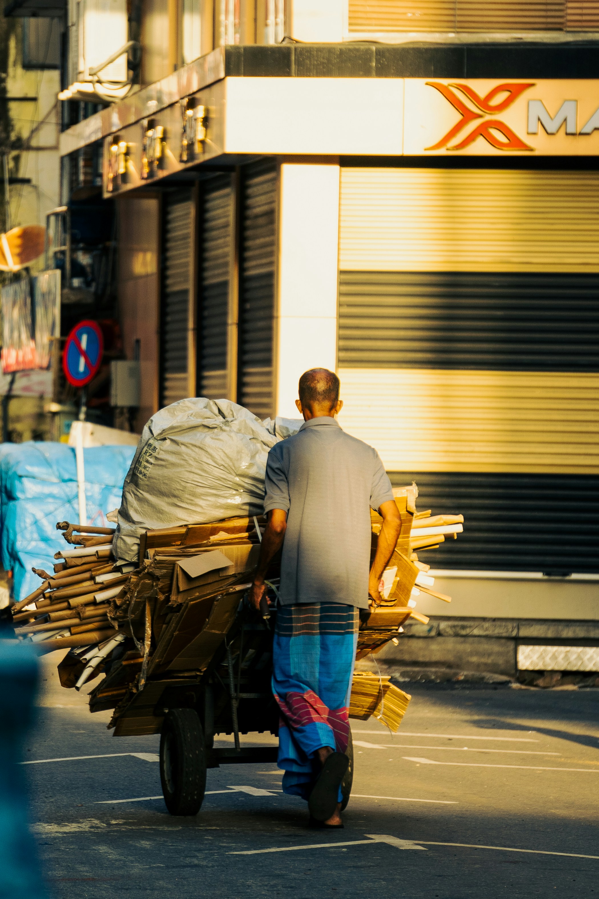 Cart of Cards: A Man Pushing a Wooden Cart Through Neon-Quiet Street