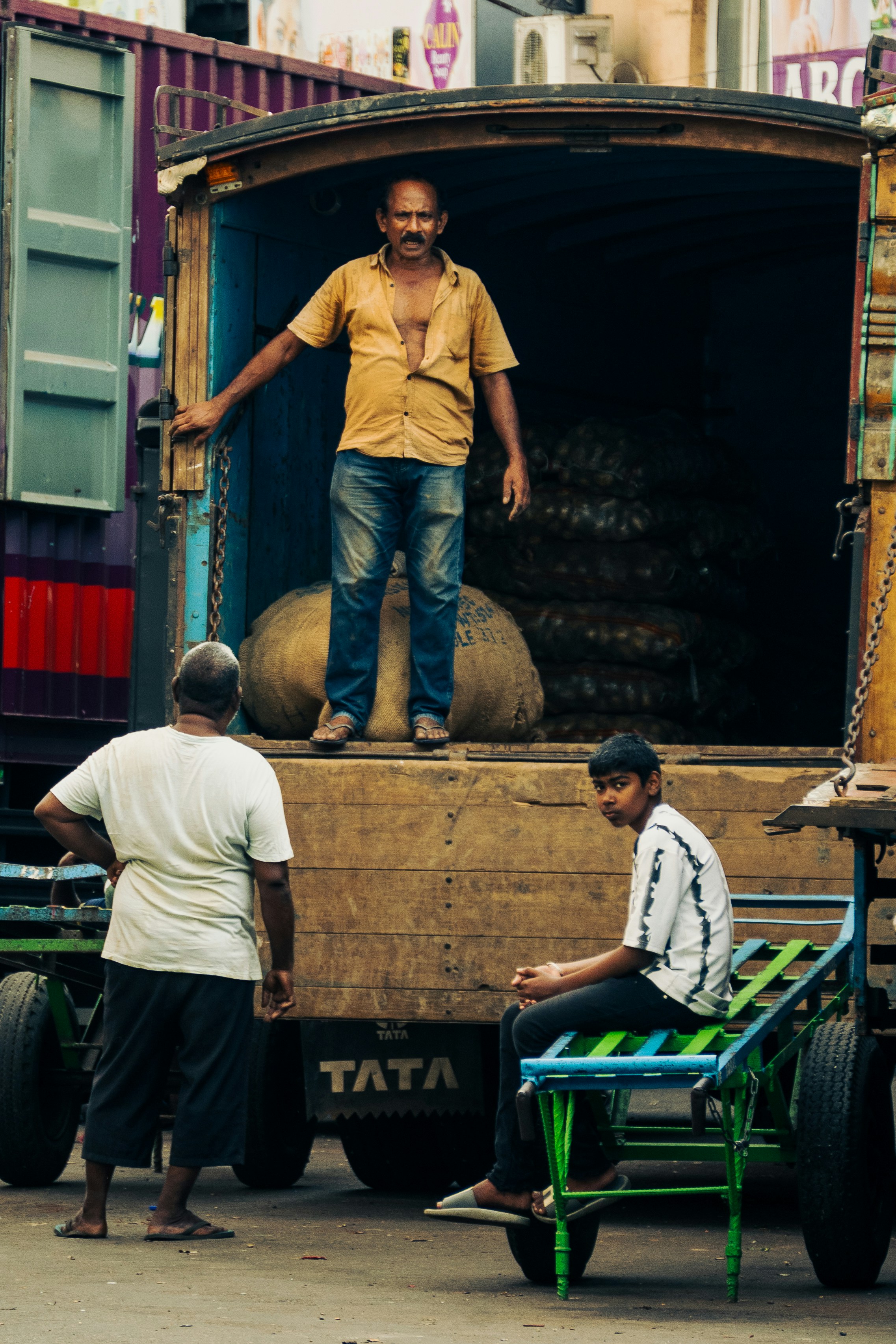 Truck-side Portrait: Man in the Truck Bed with Boys Nearby