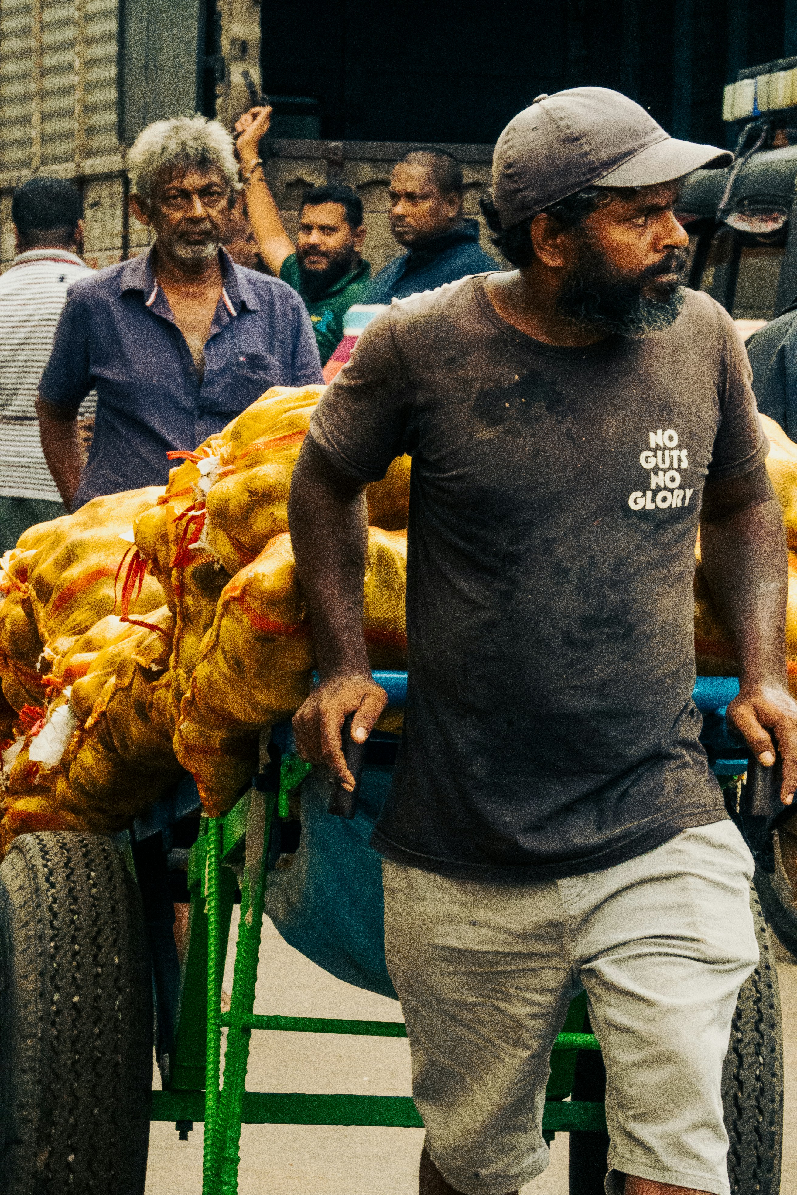 Cart with Weight of Labor: A Moment on a Busy Street
