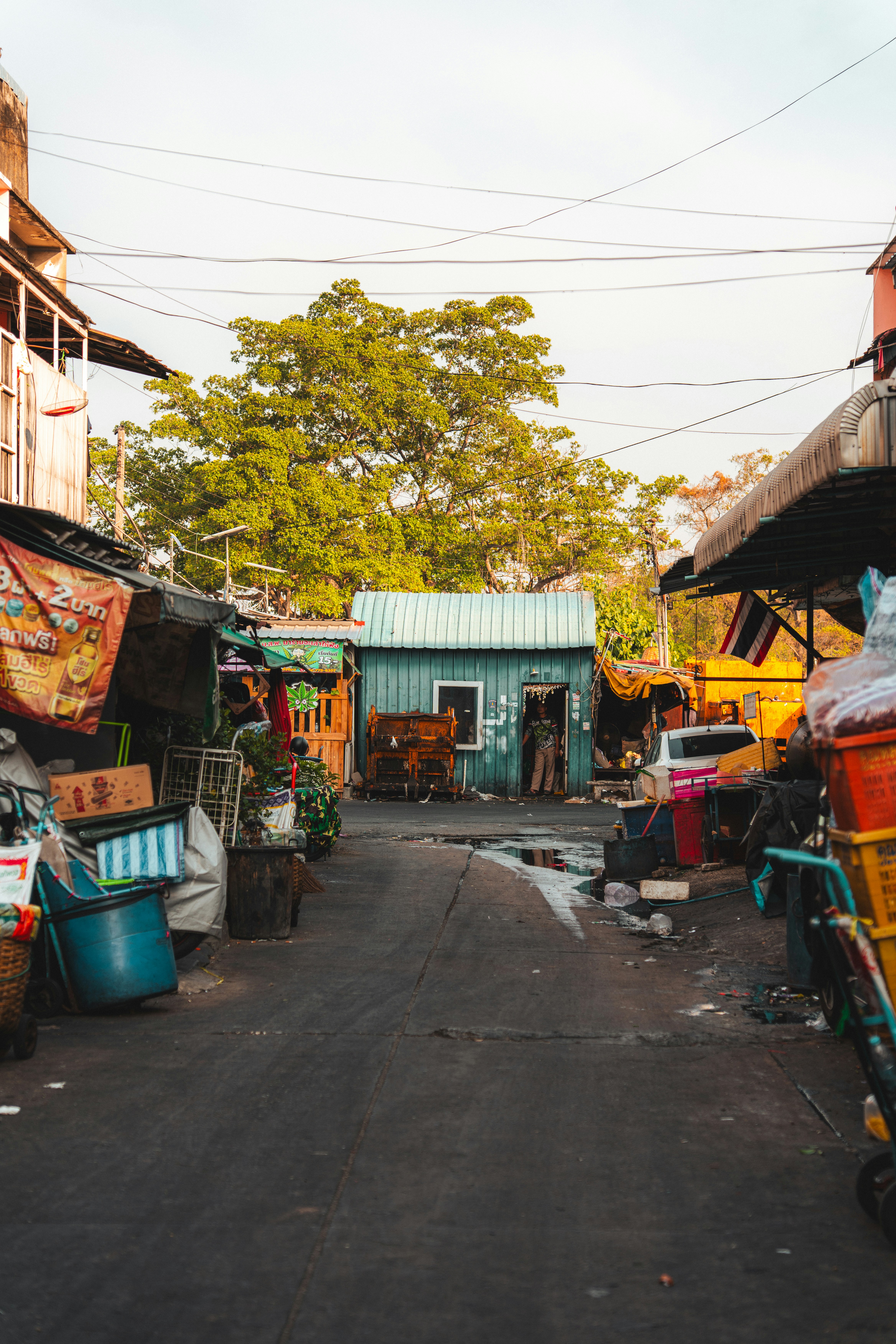 Midday Alleyway Pastels: A Quiet Market Corridor Framed by Colorful Shacks