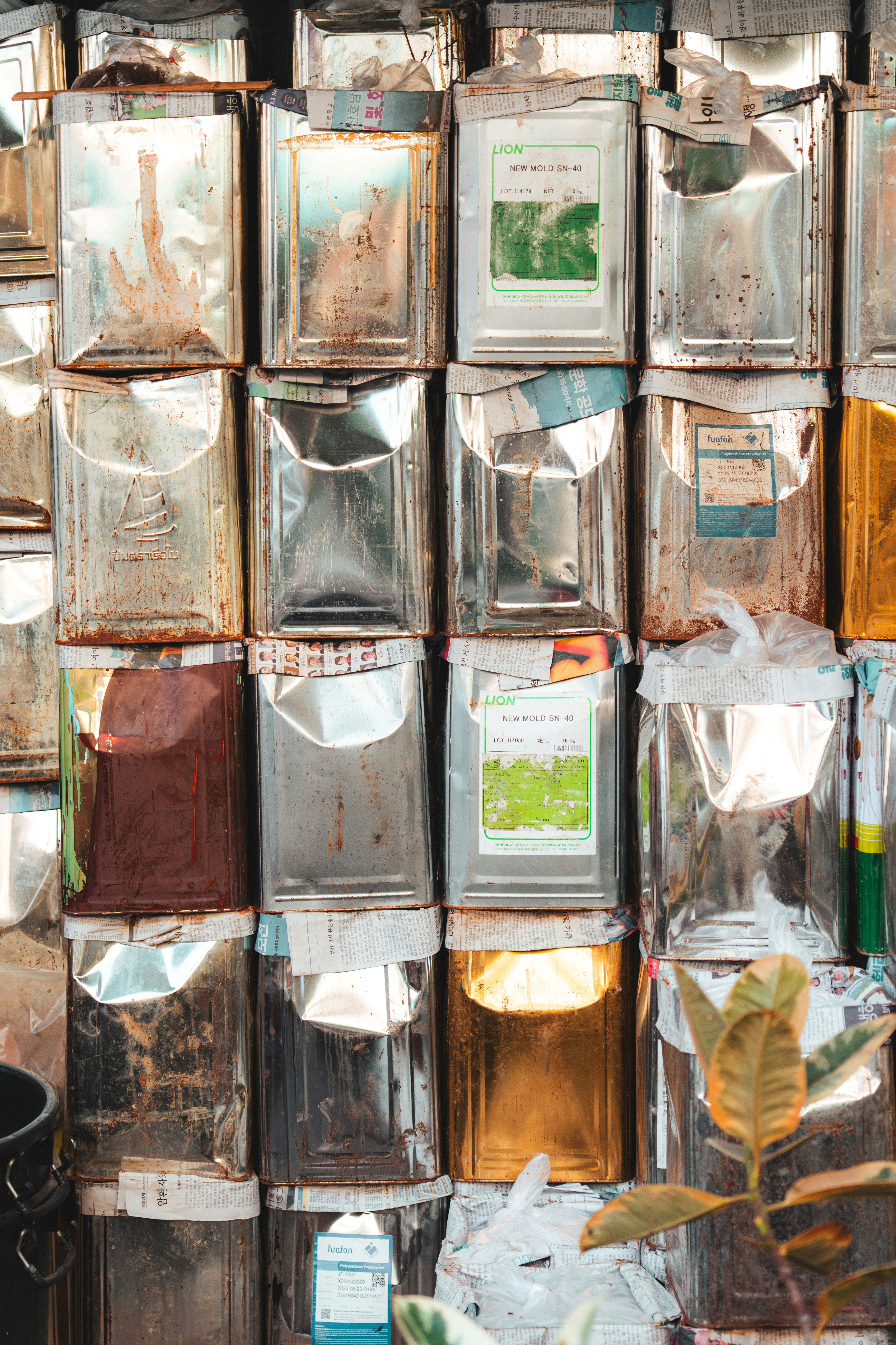 Rust and Reflection: A Grid of Dented Metal Containers