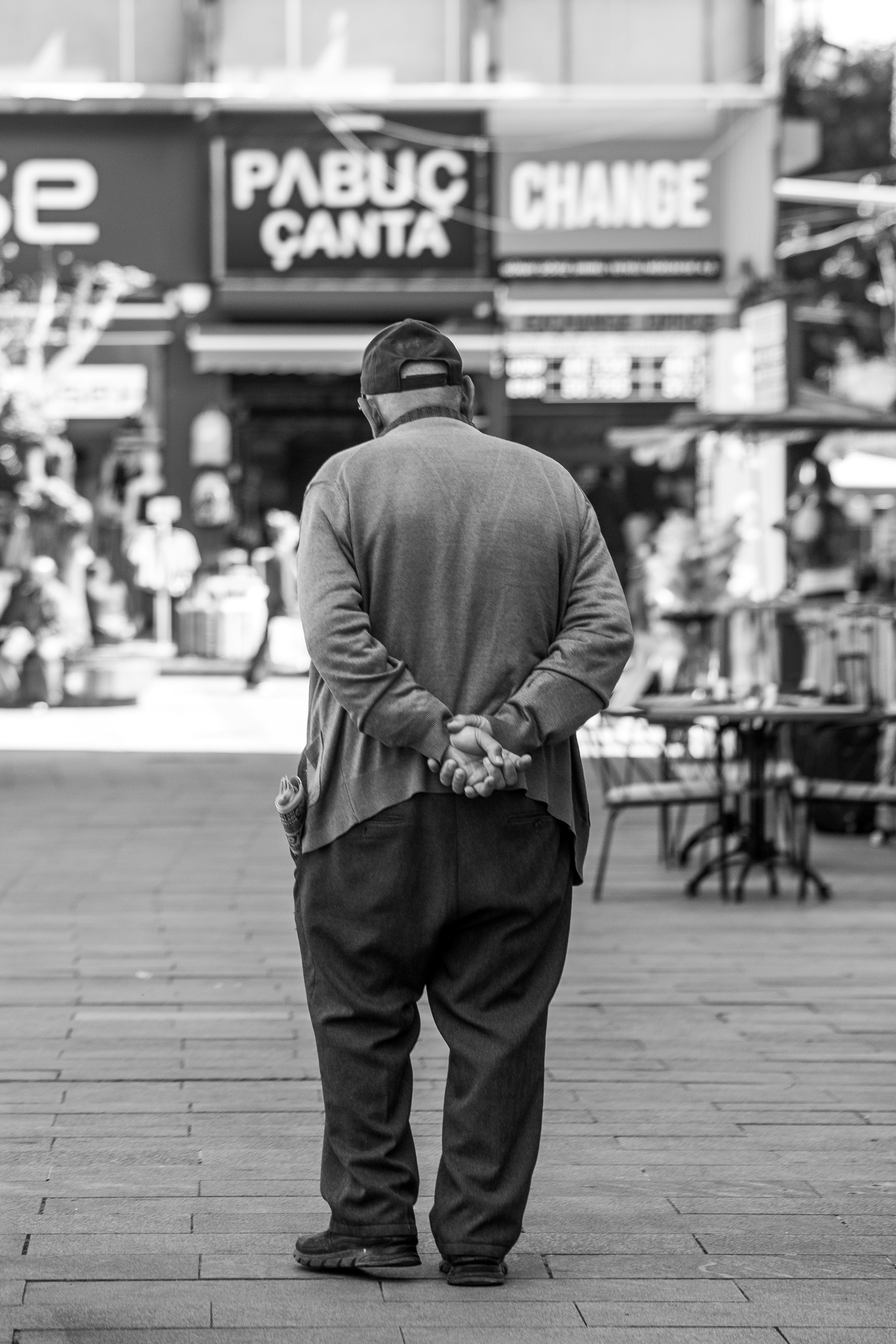 Backs Turned in the Market: A Quiet Moment Amidst the Crowd