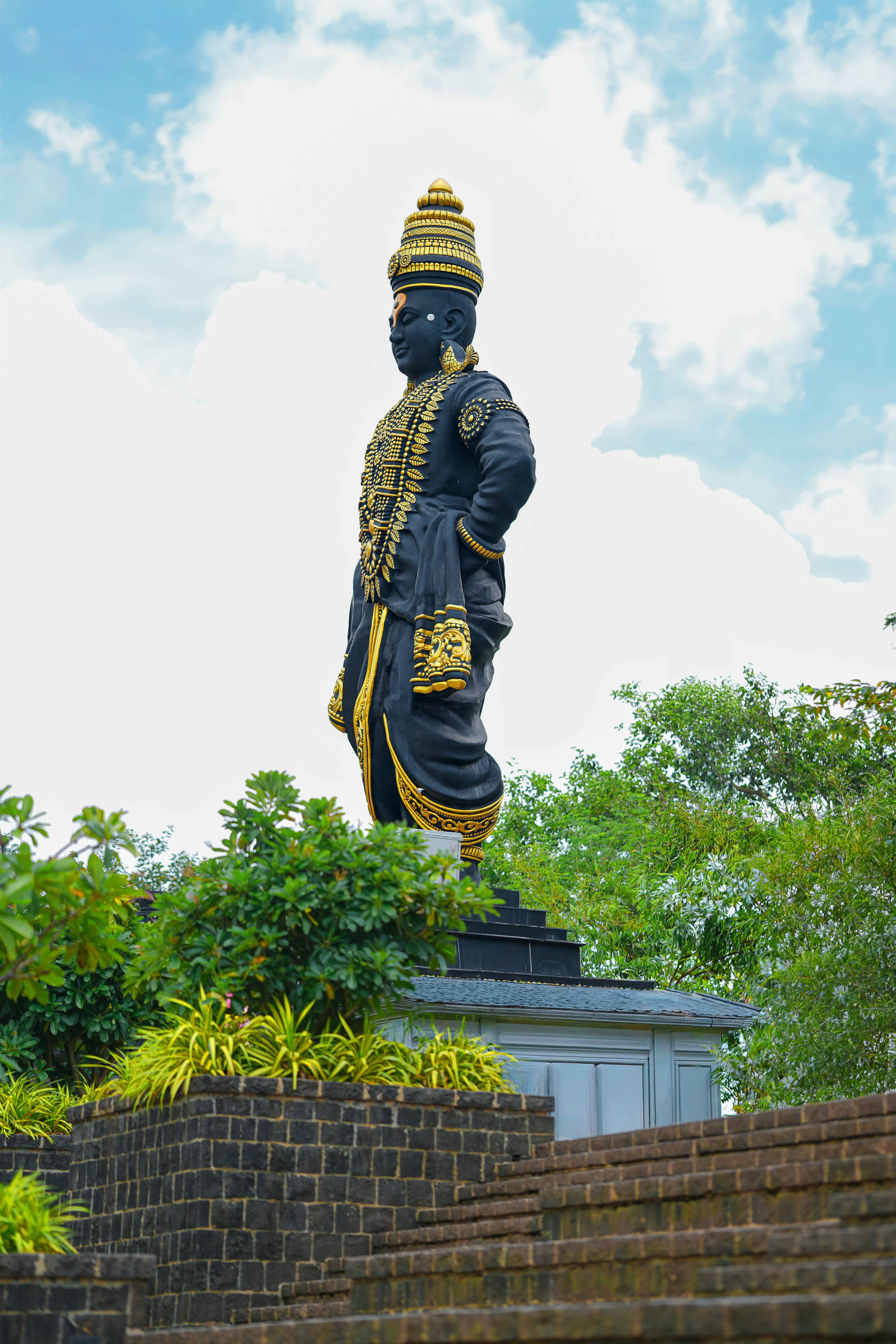Majestic statue rising above brick terraces